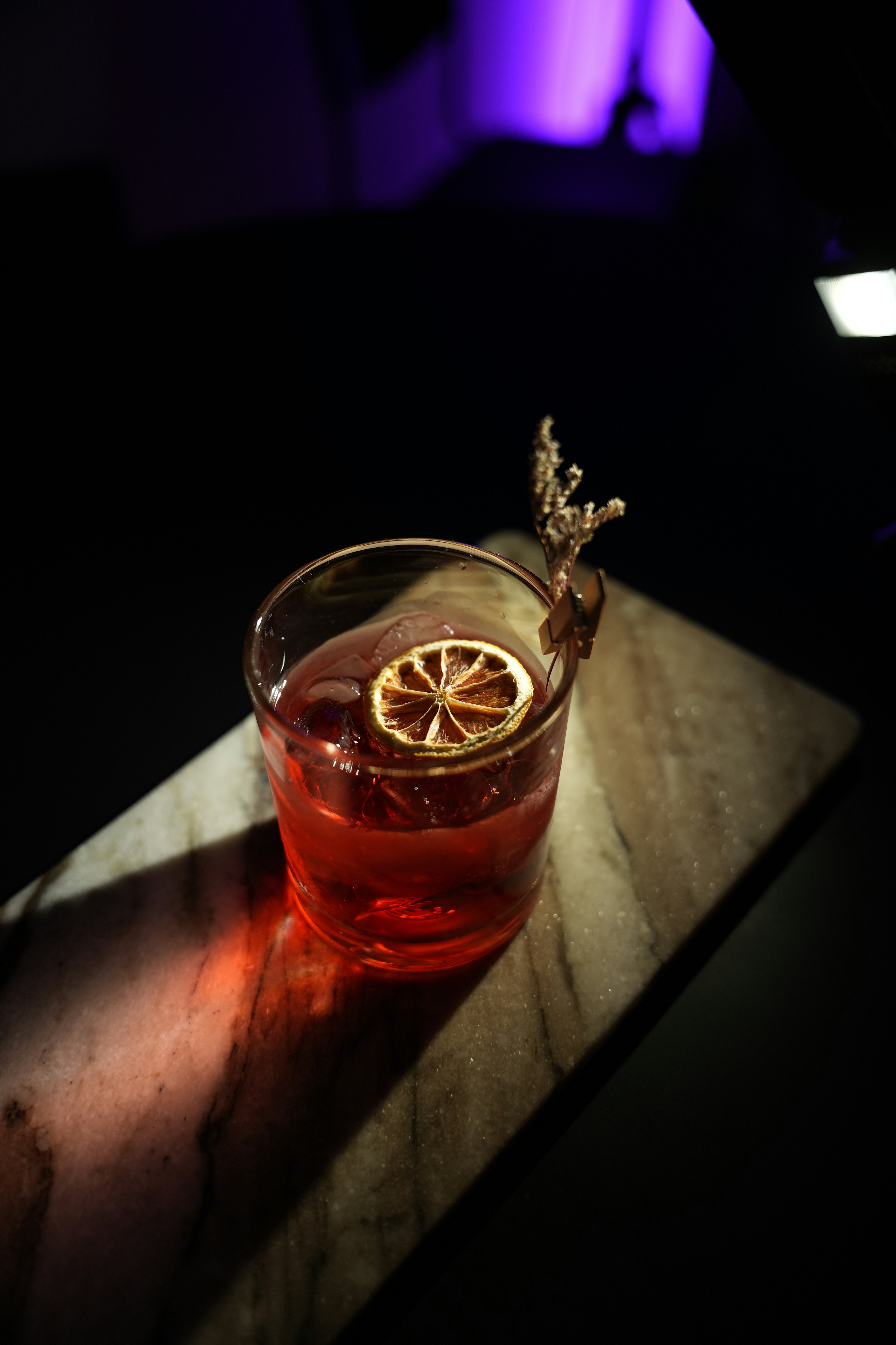 Crimson Carafe on Marble: A Quiet Nightcap Under The Violet Glow