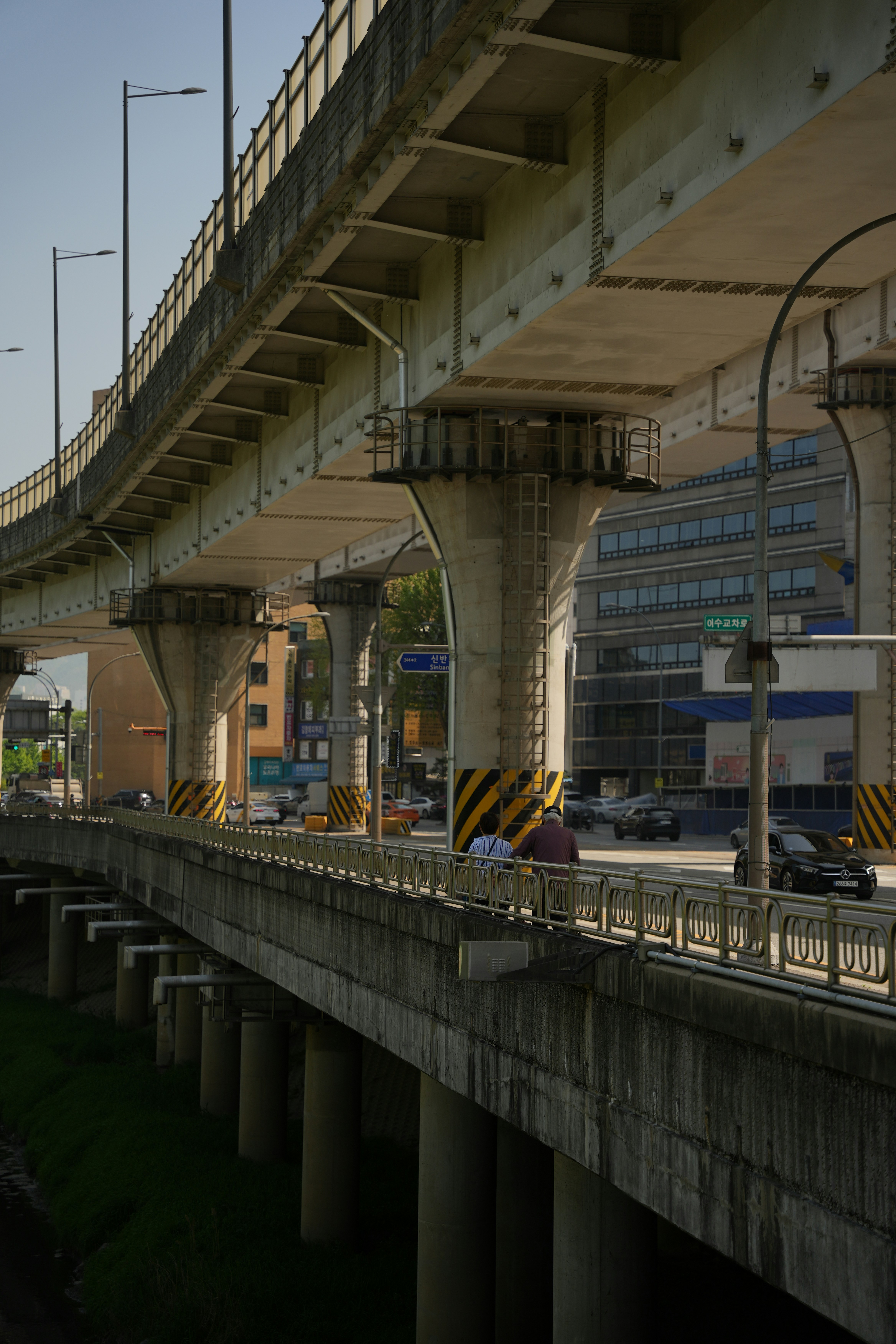 An elevated highway spans above streets and buildings.