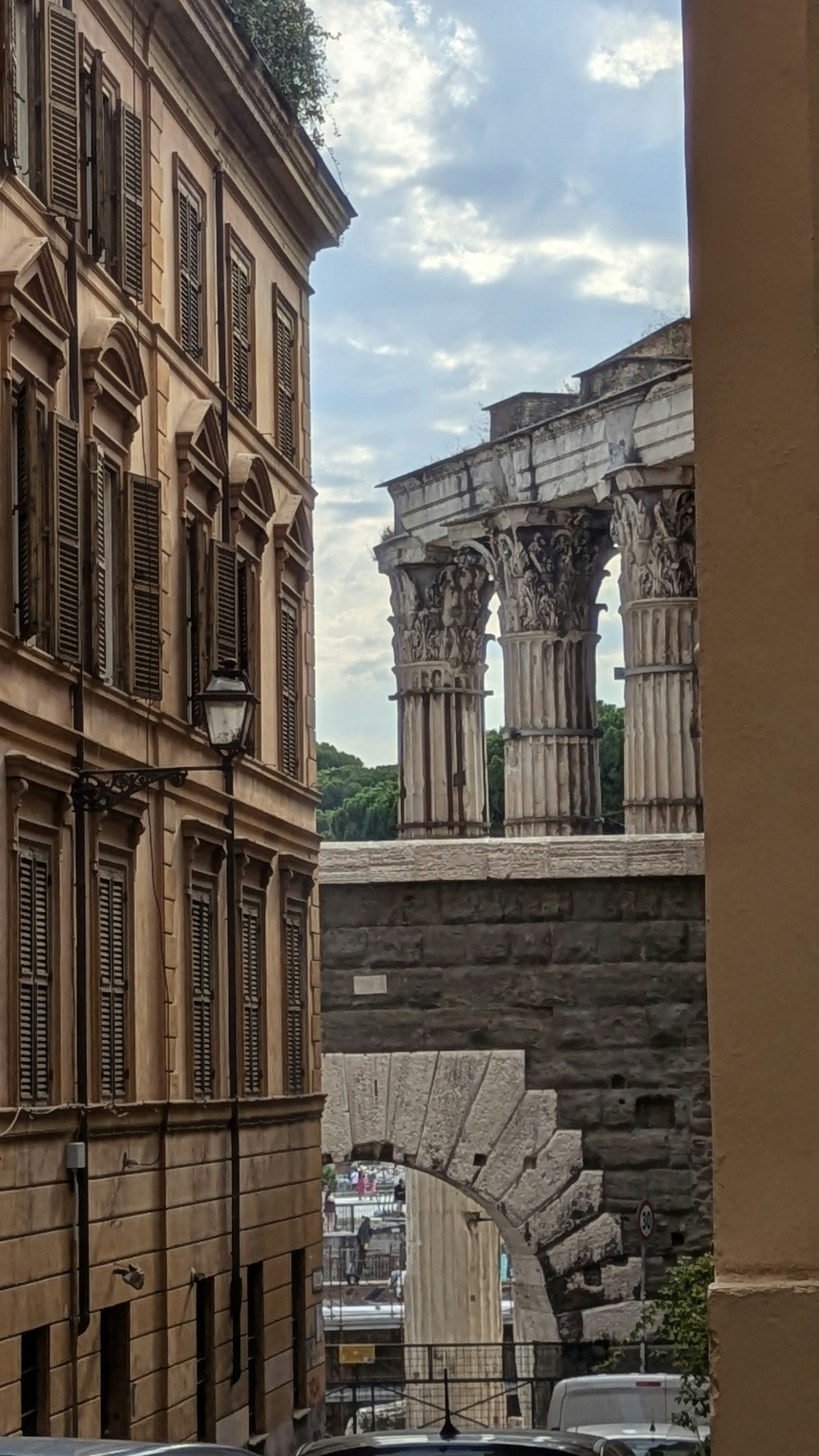 Between passages in the center of Rome, appears the rest of the ancient Rome which was build around 300 bc. More than 3000 years later and we can still see the robust construction! | Building and pillars in a european street.