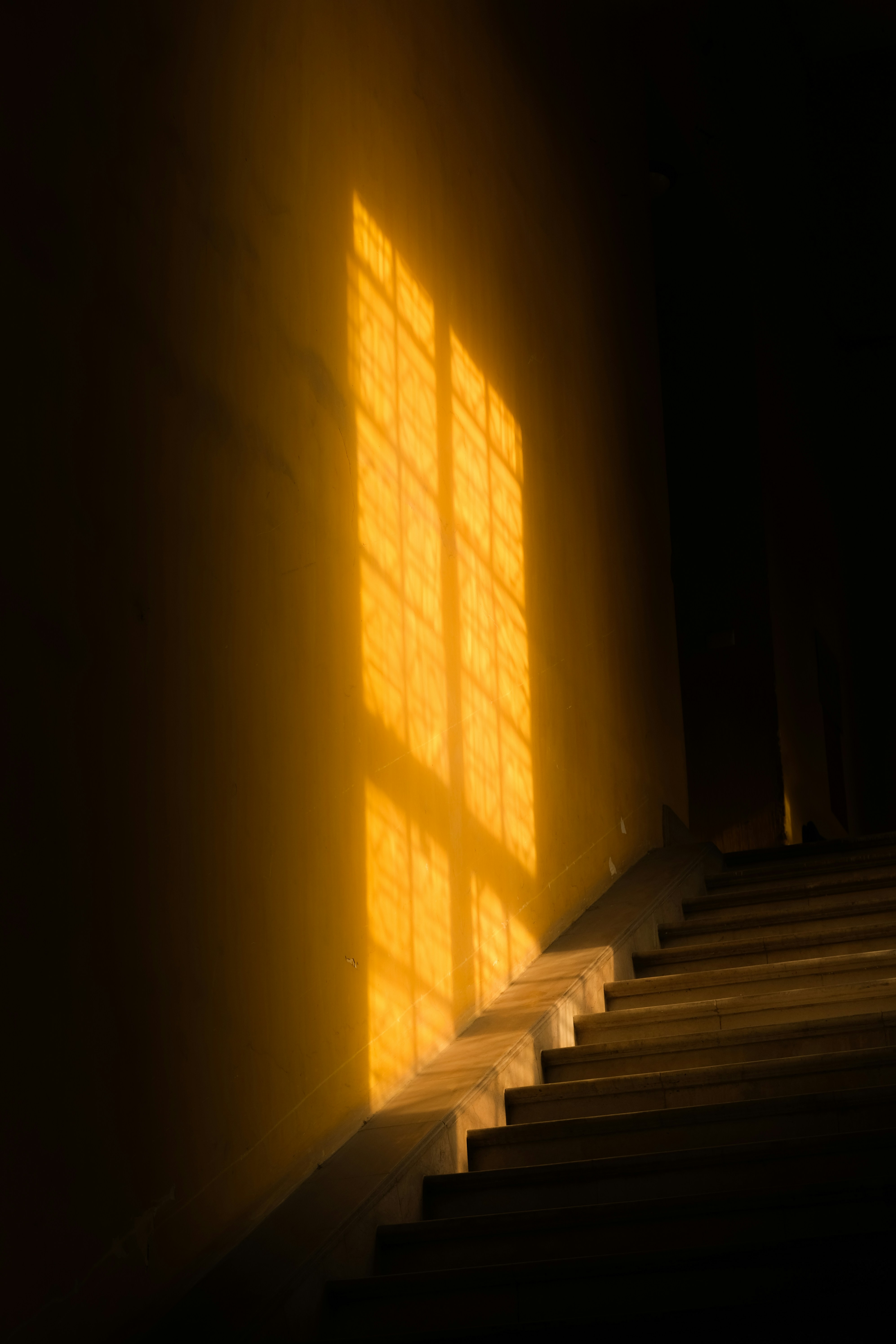 Sunlight illuminates a window and stairs.