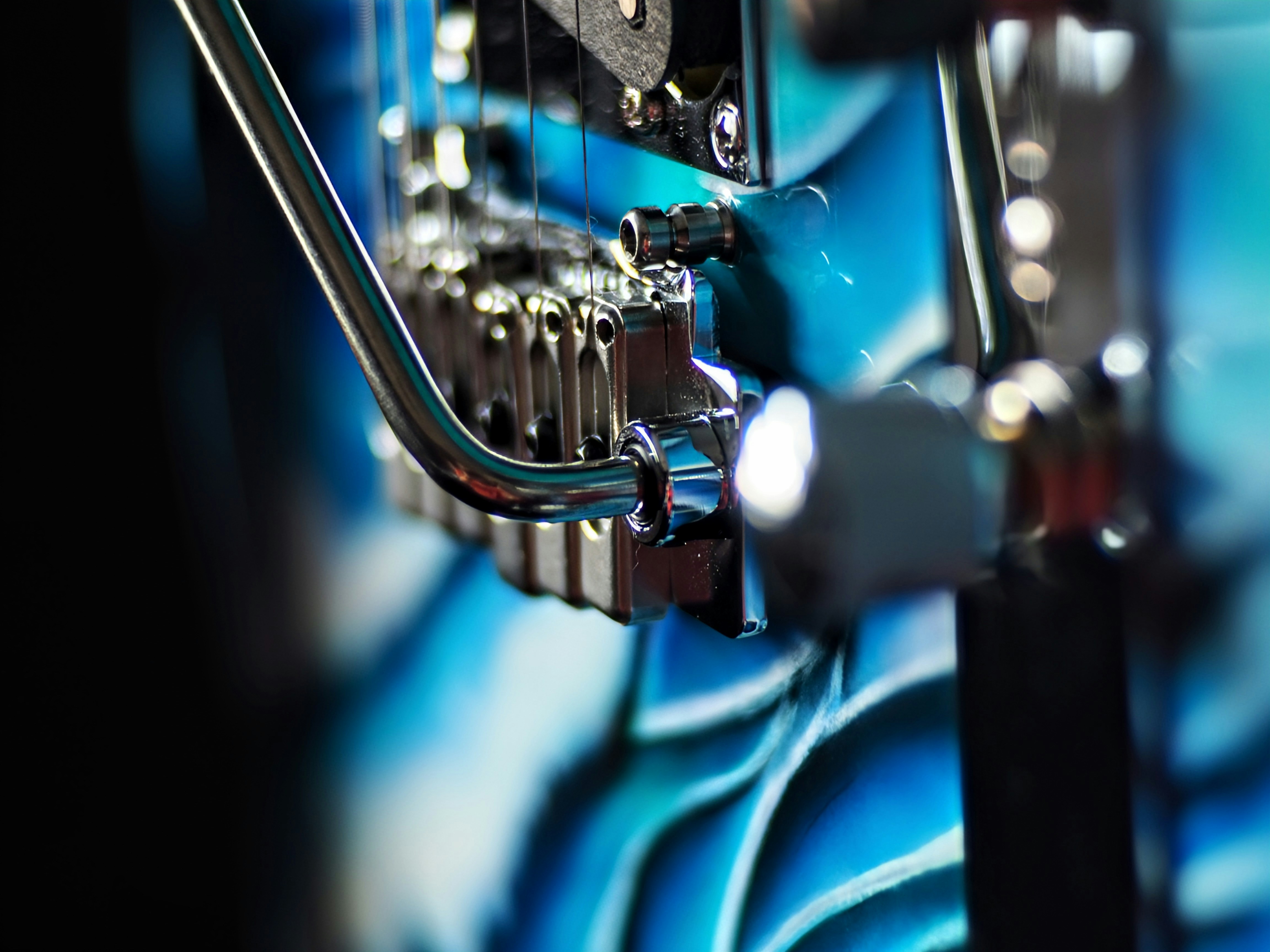 Blue Guitar | Close-up shot of a guitar's bridge and strings.