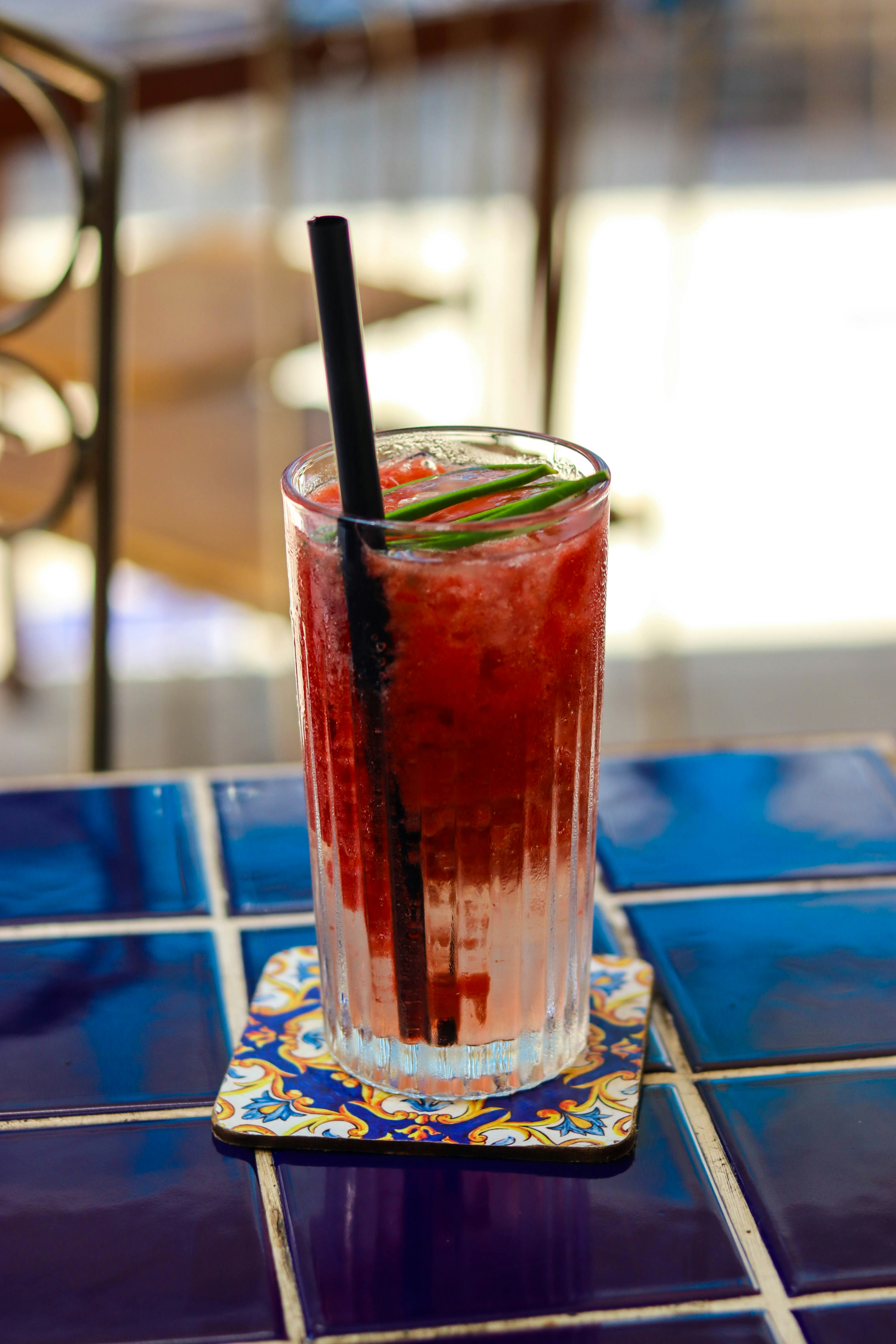 A refreshing cocktail with black straw.