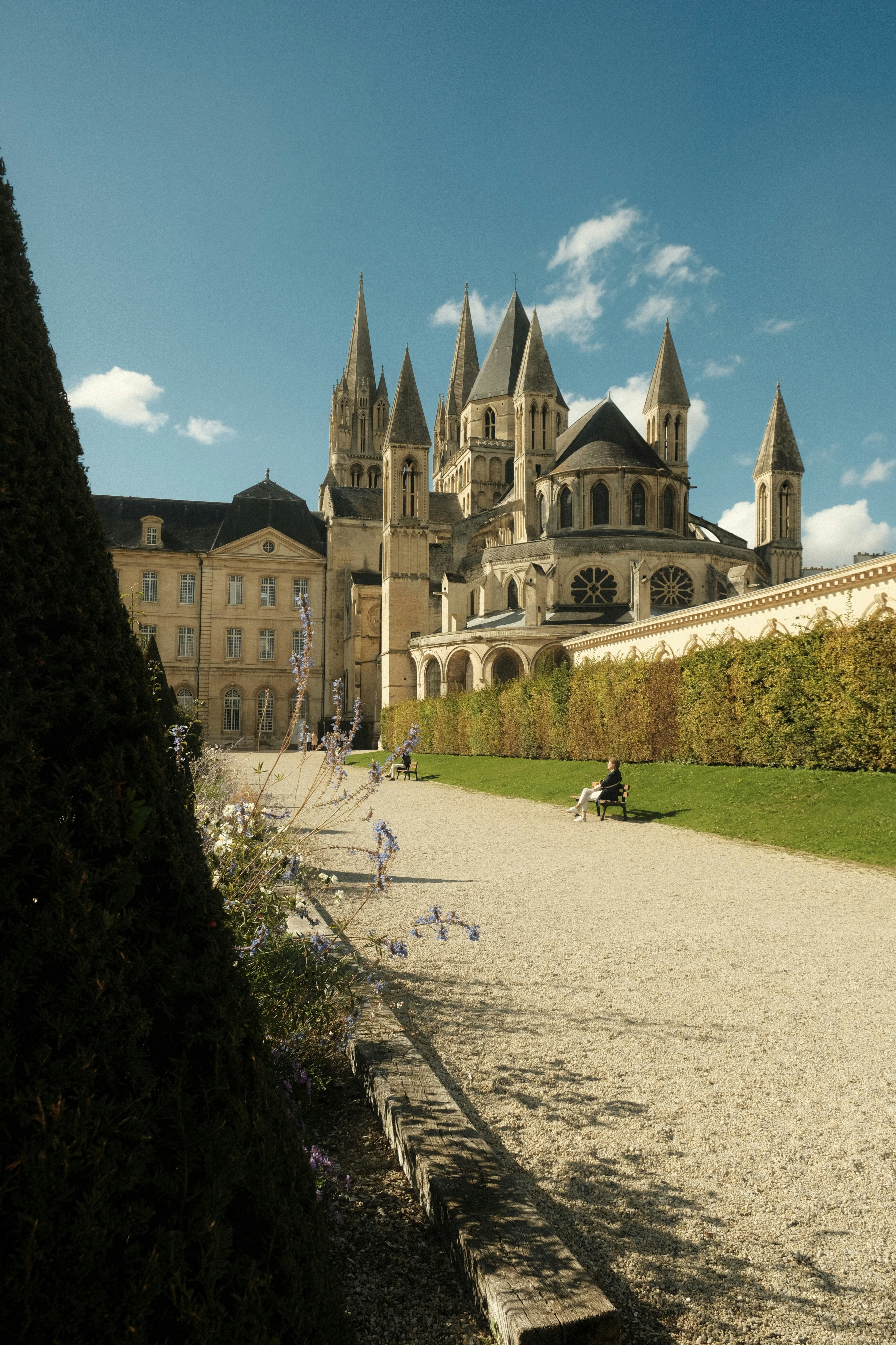 A majestic cathedral stands tall in a garden.