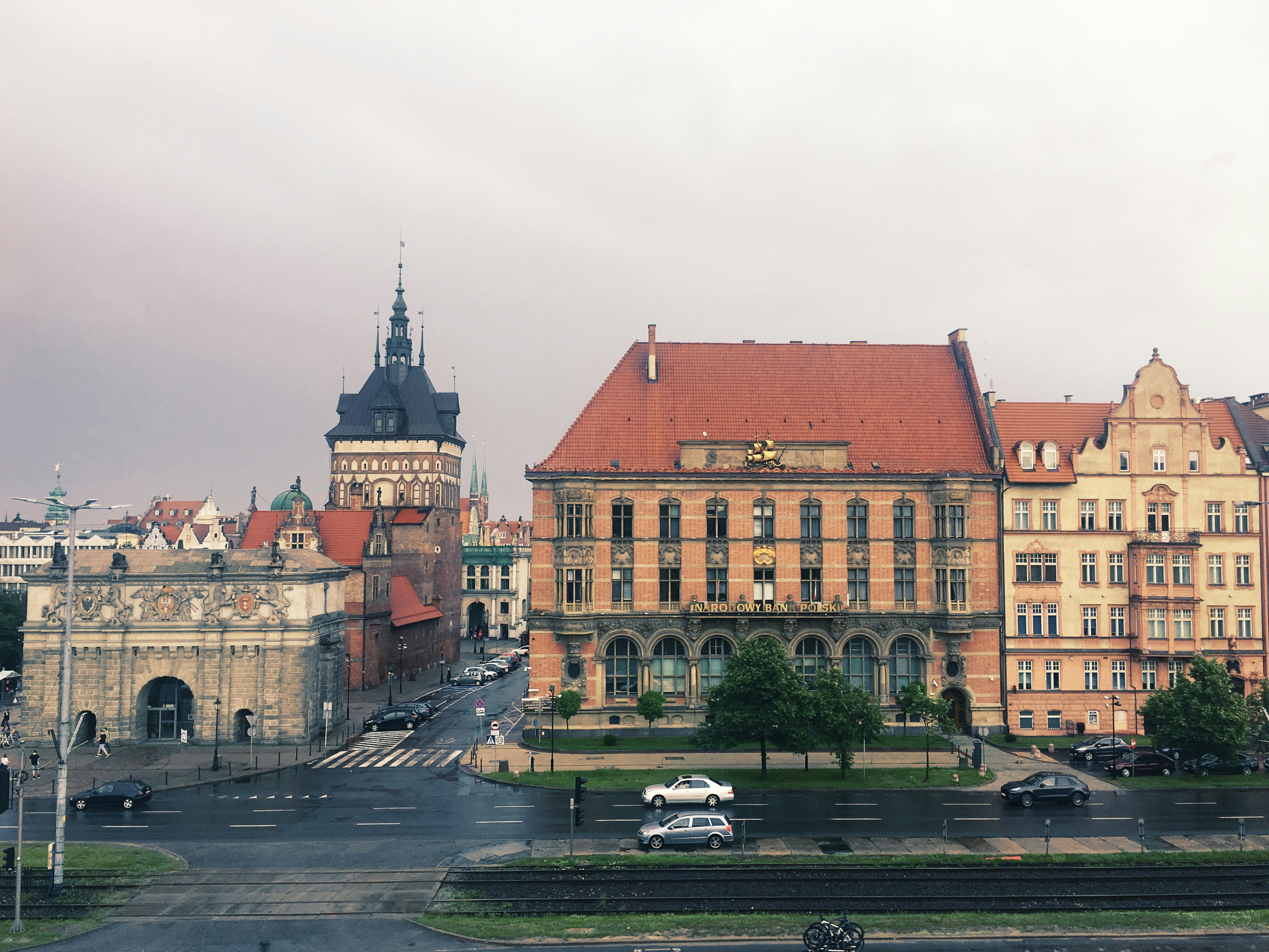 Cityscape with historic buildings under an overcast sky.