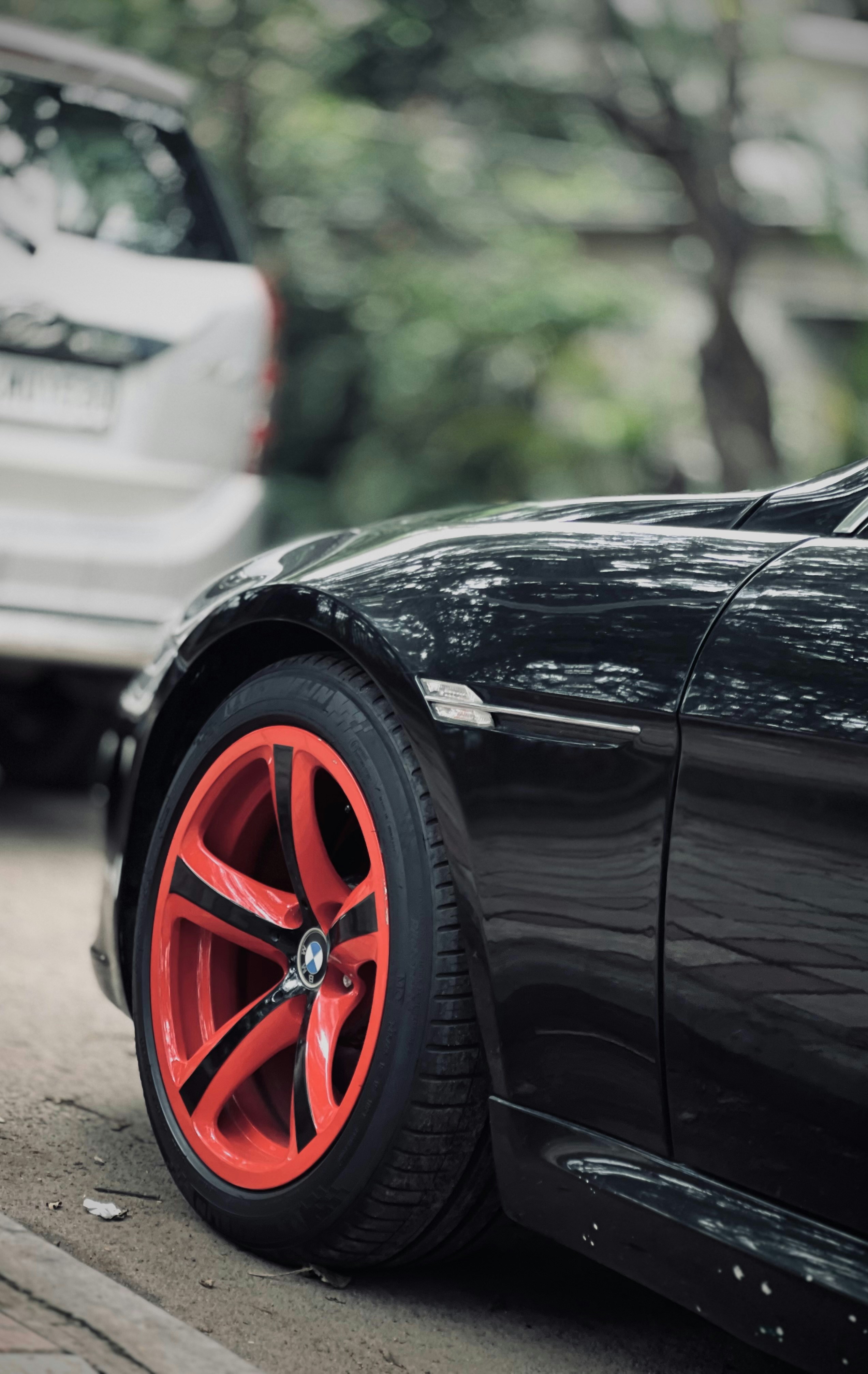 A black car with red rims.
