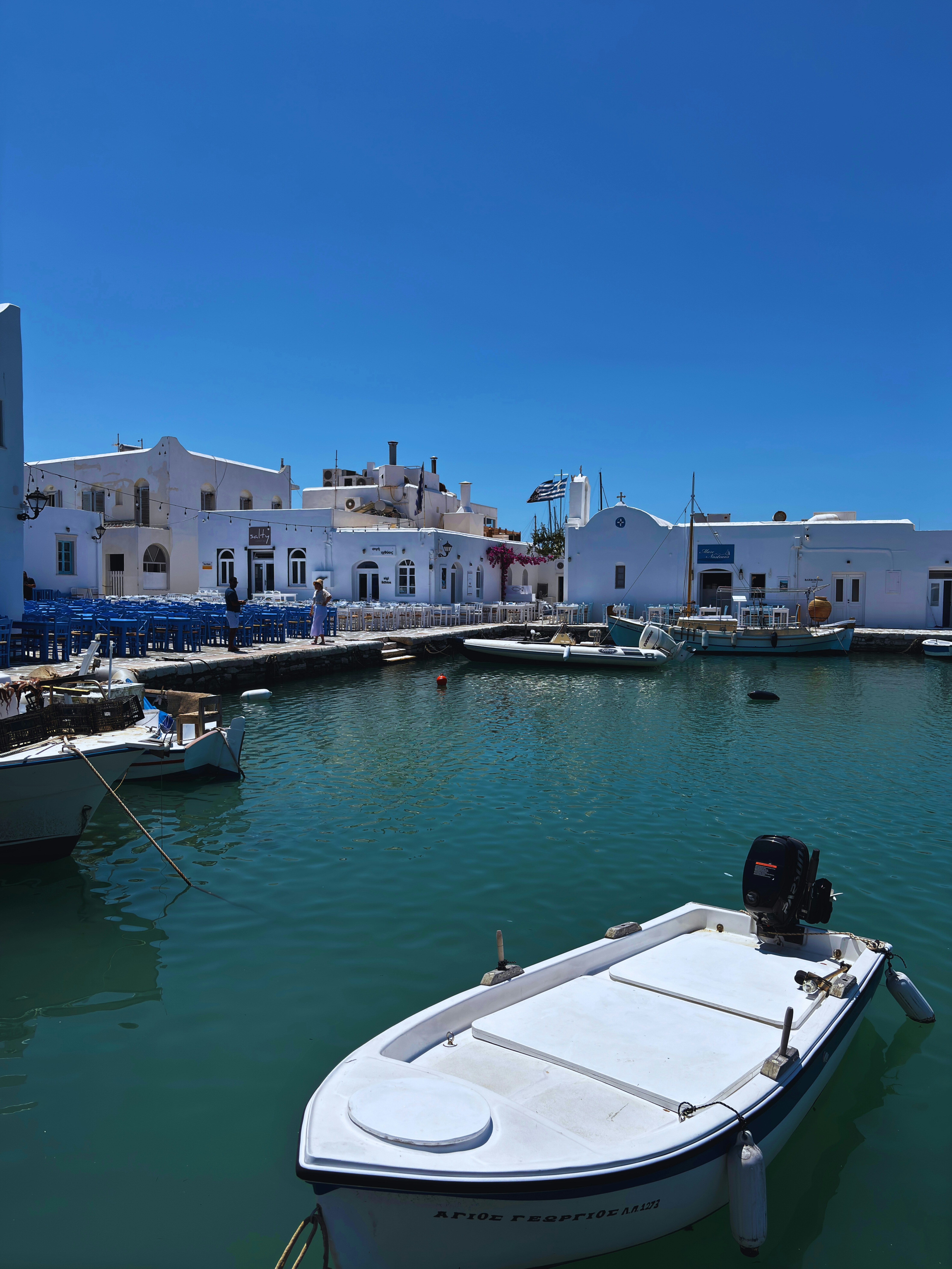 Boats float in a beautiful, blue greek harbor. photo – Free Greece ...