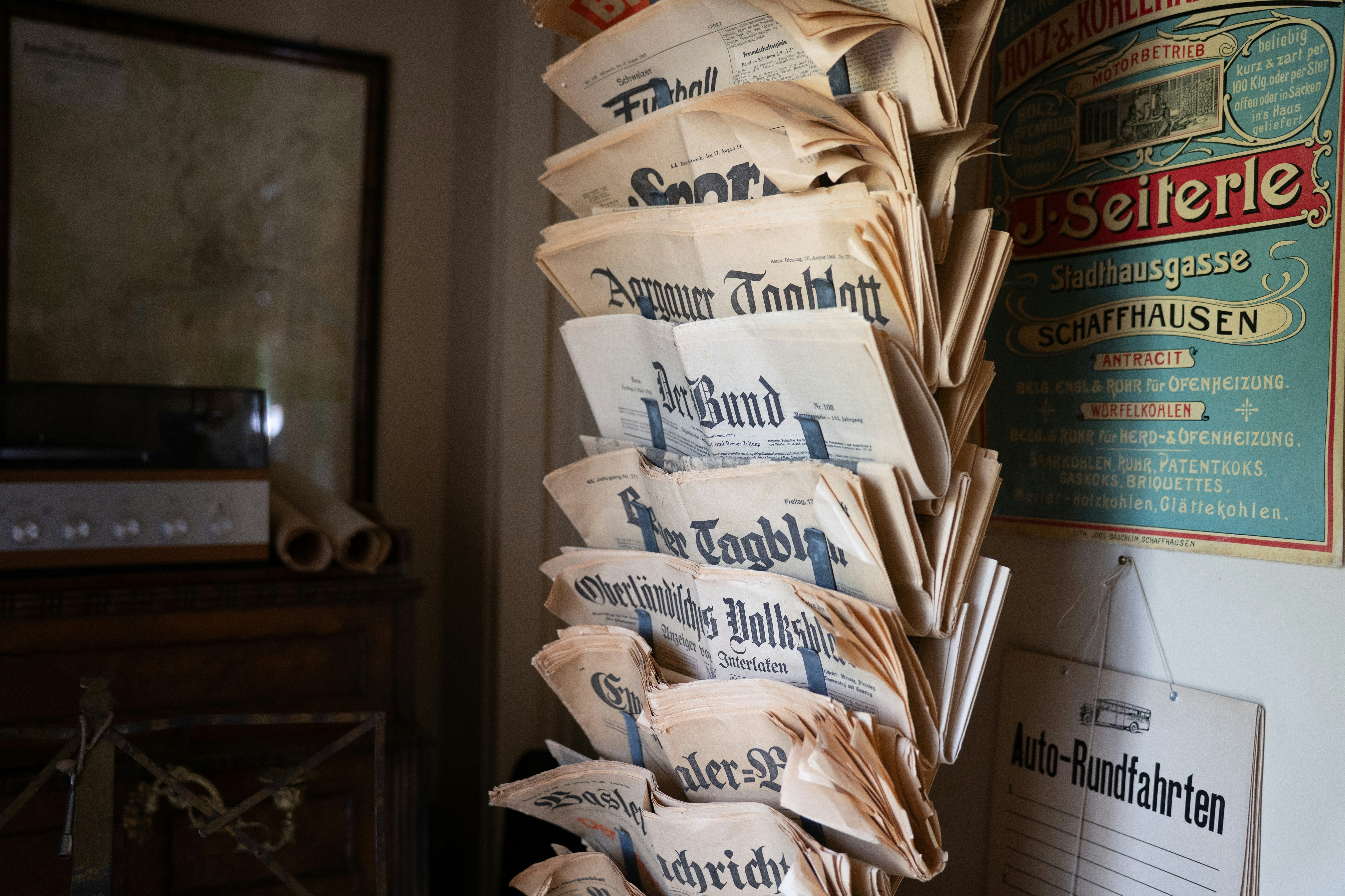 Newspapers in a wooden rack.