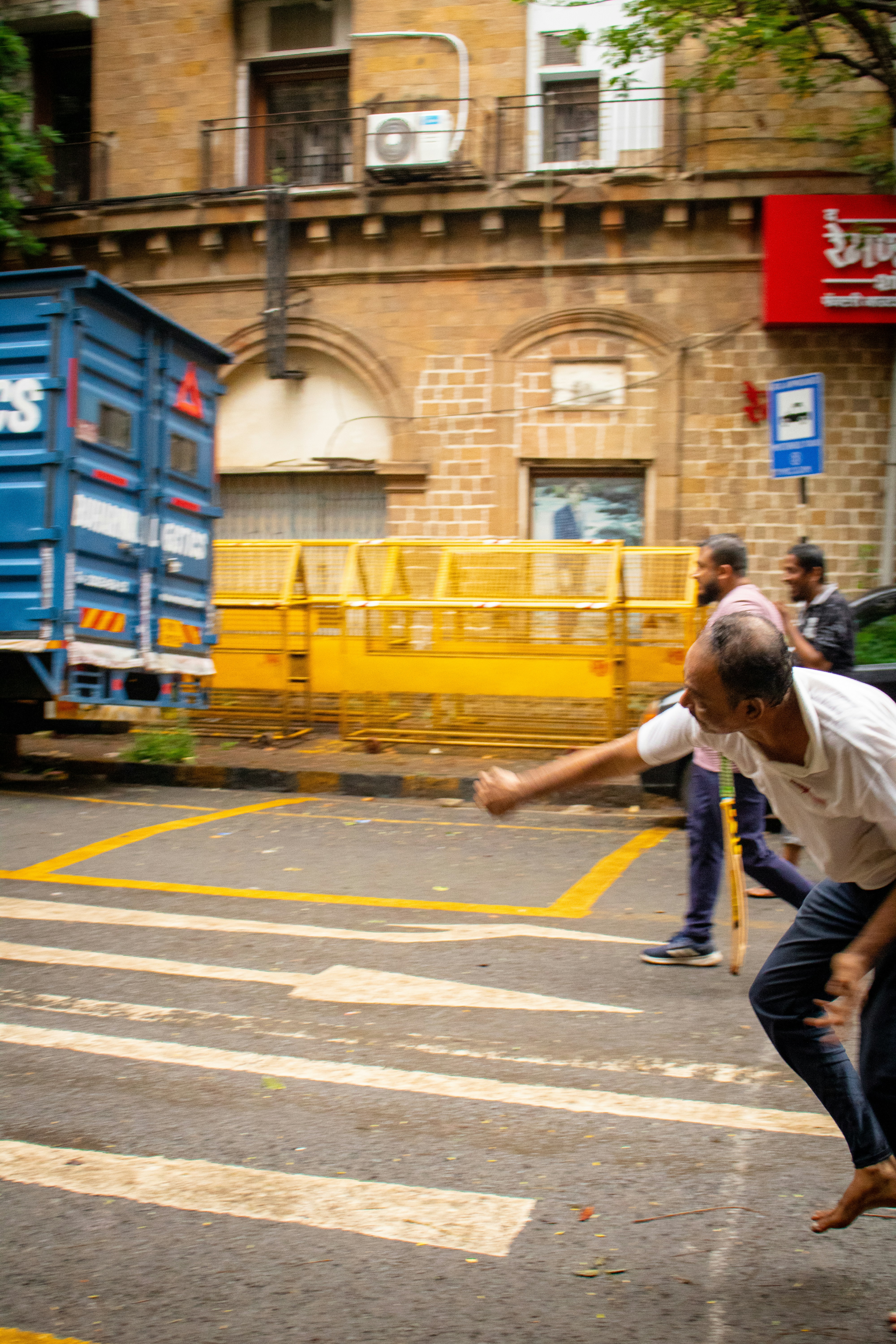 A man appears to throw something in the street. photo – Free City Image ...