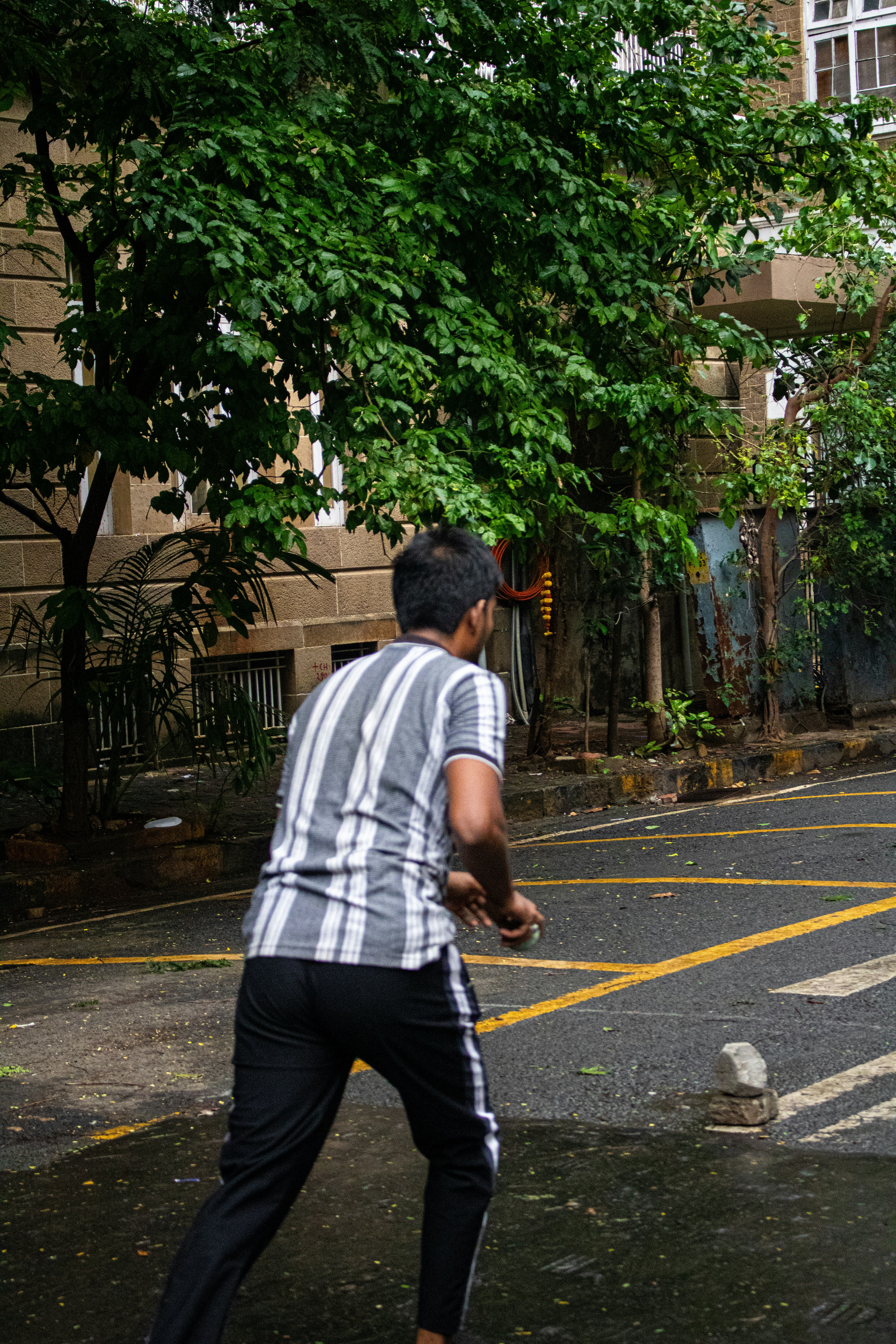 Midstride in a Quiet Parking Lot: Striped Shirt Runner