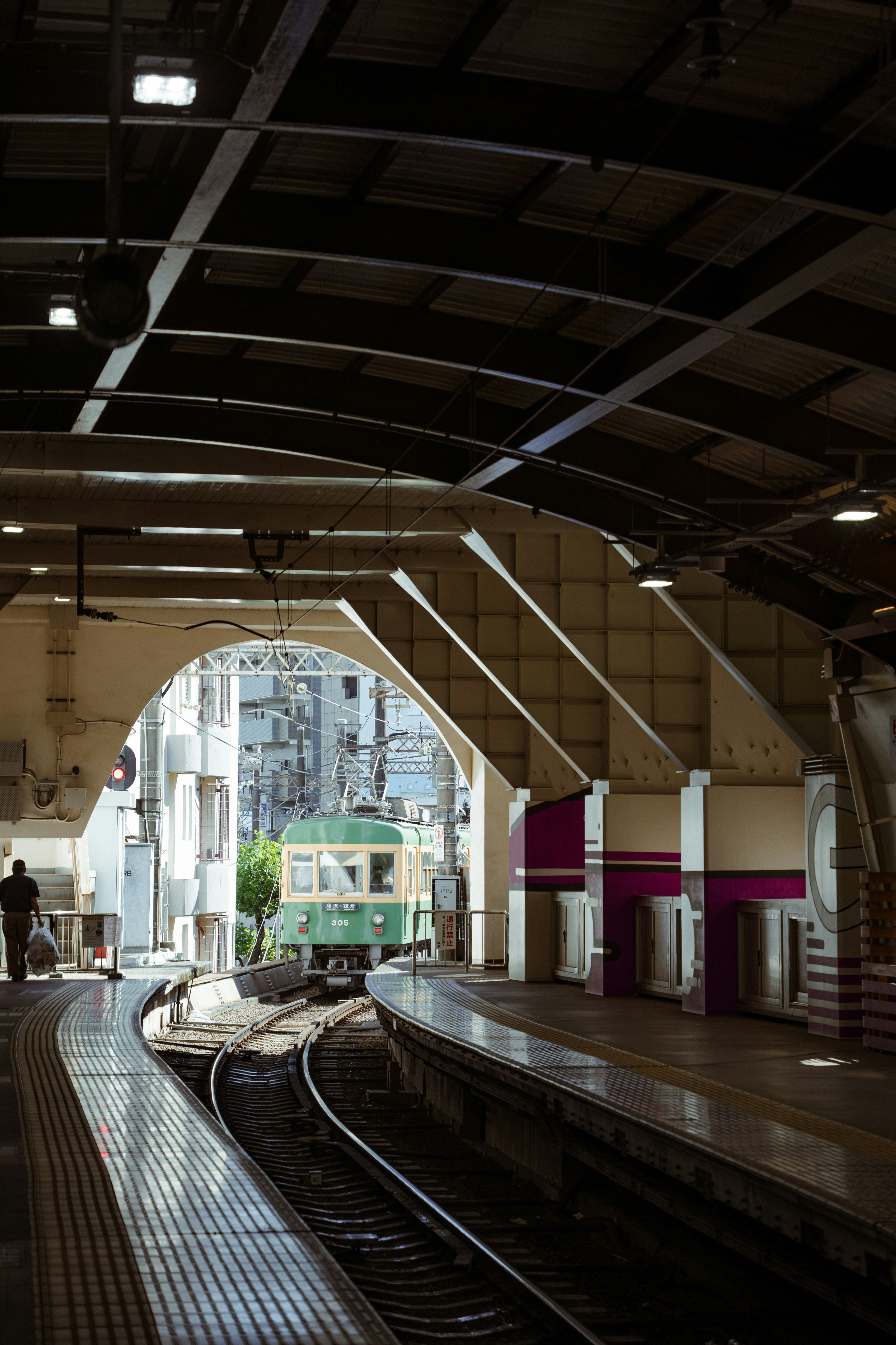 A train pulls into a station along tracks.