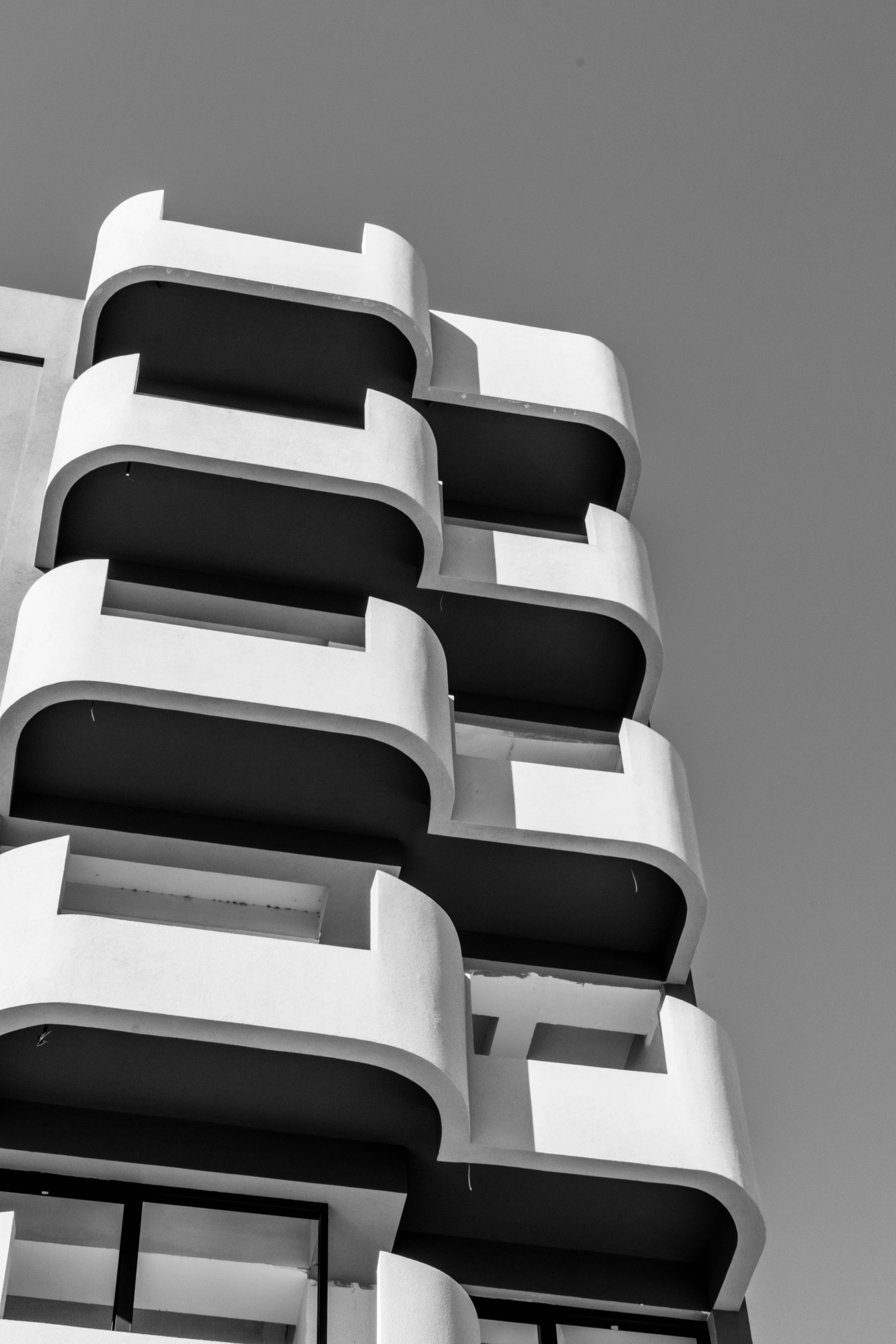 Monochrome Curve Stack: a vertical rhythm of balconies