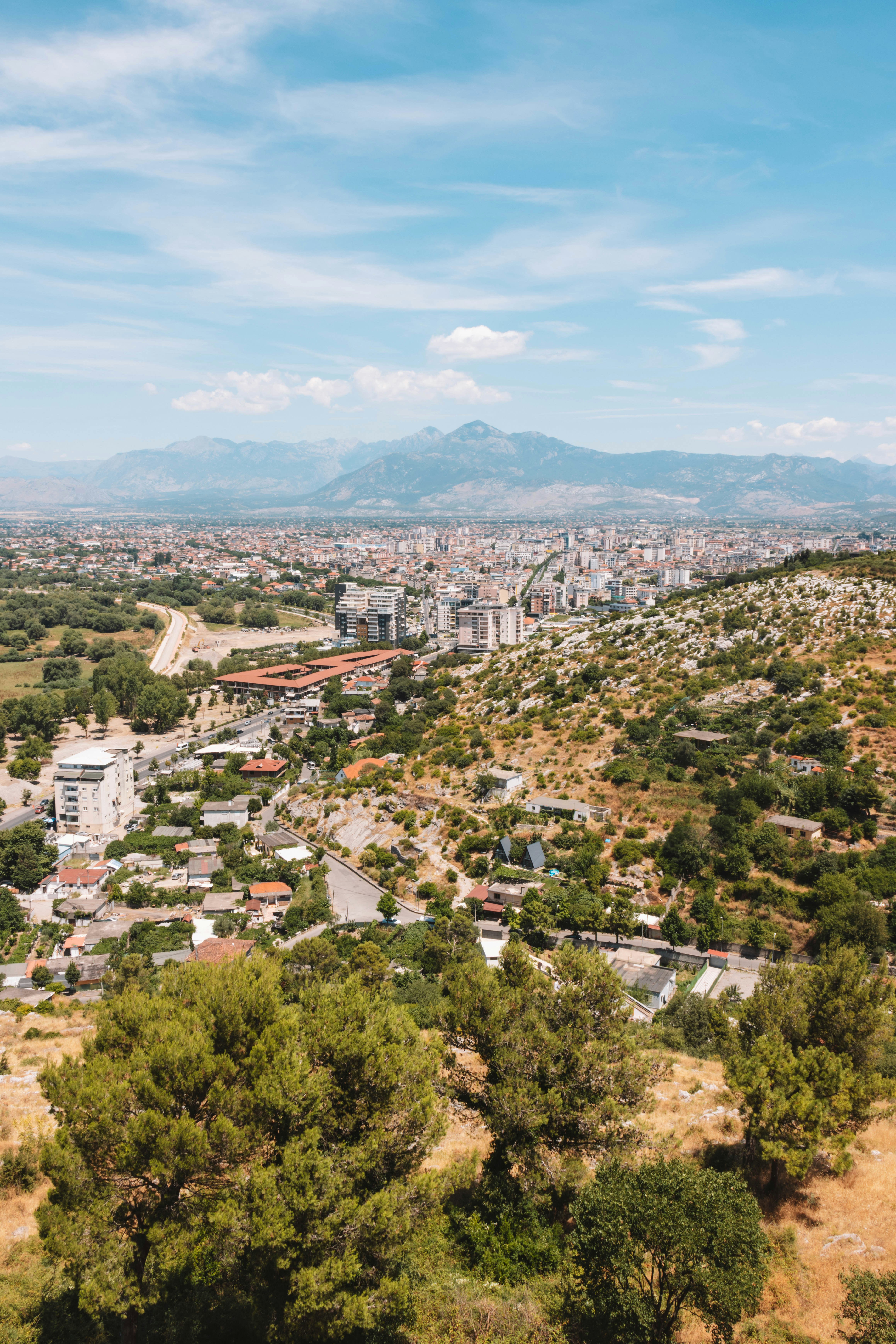 Aerial view of a city with mountains in the background.