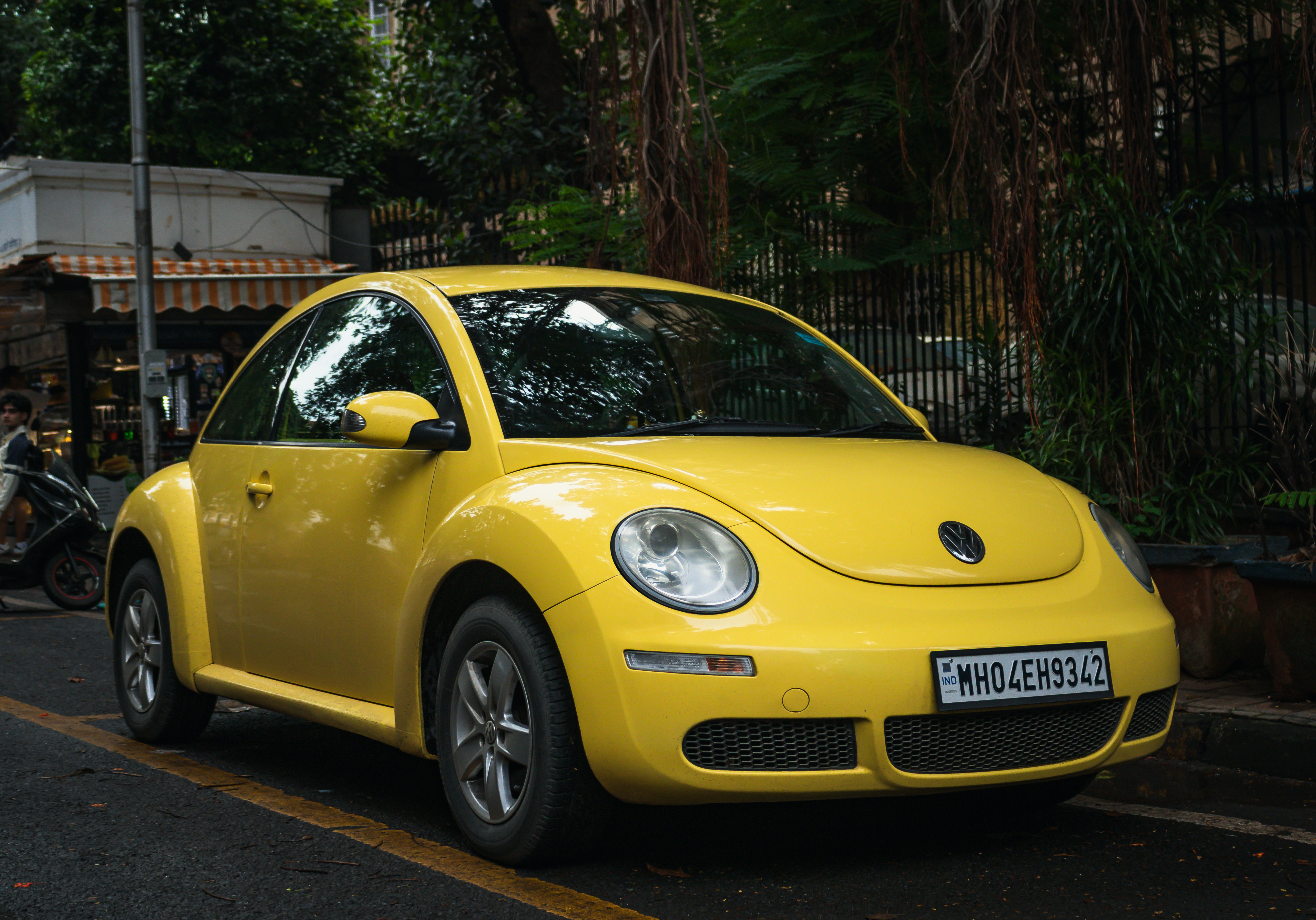 Sunny Yellow Volkswagen Beetle Anchors a Quiet City Street