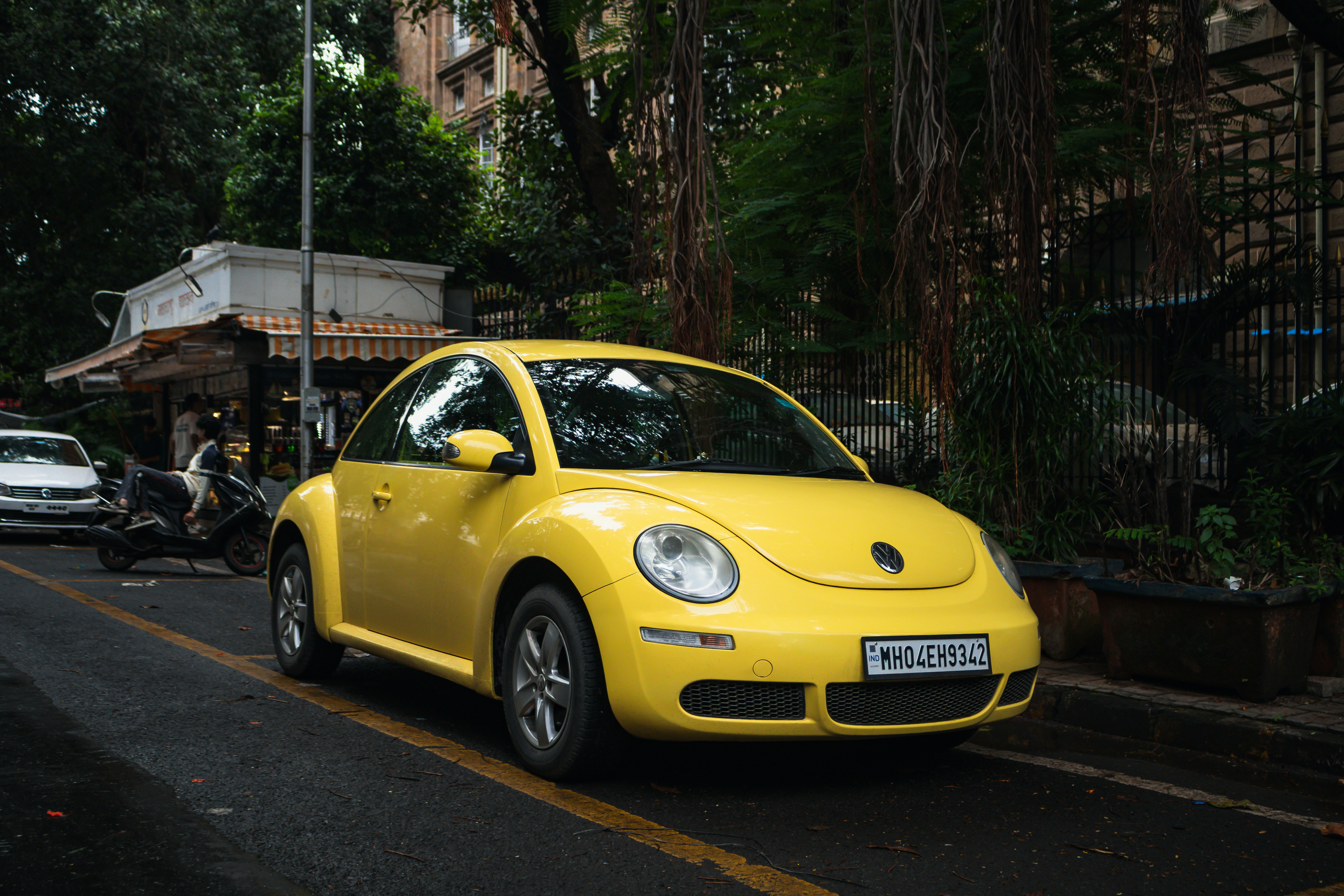 Sunlit Yellow Beetle Anchors a Rain-Washed City Street