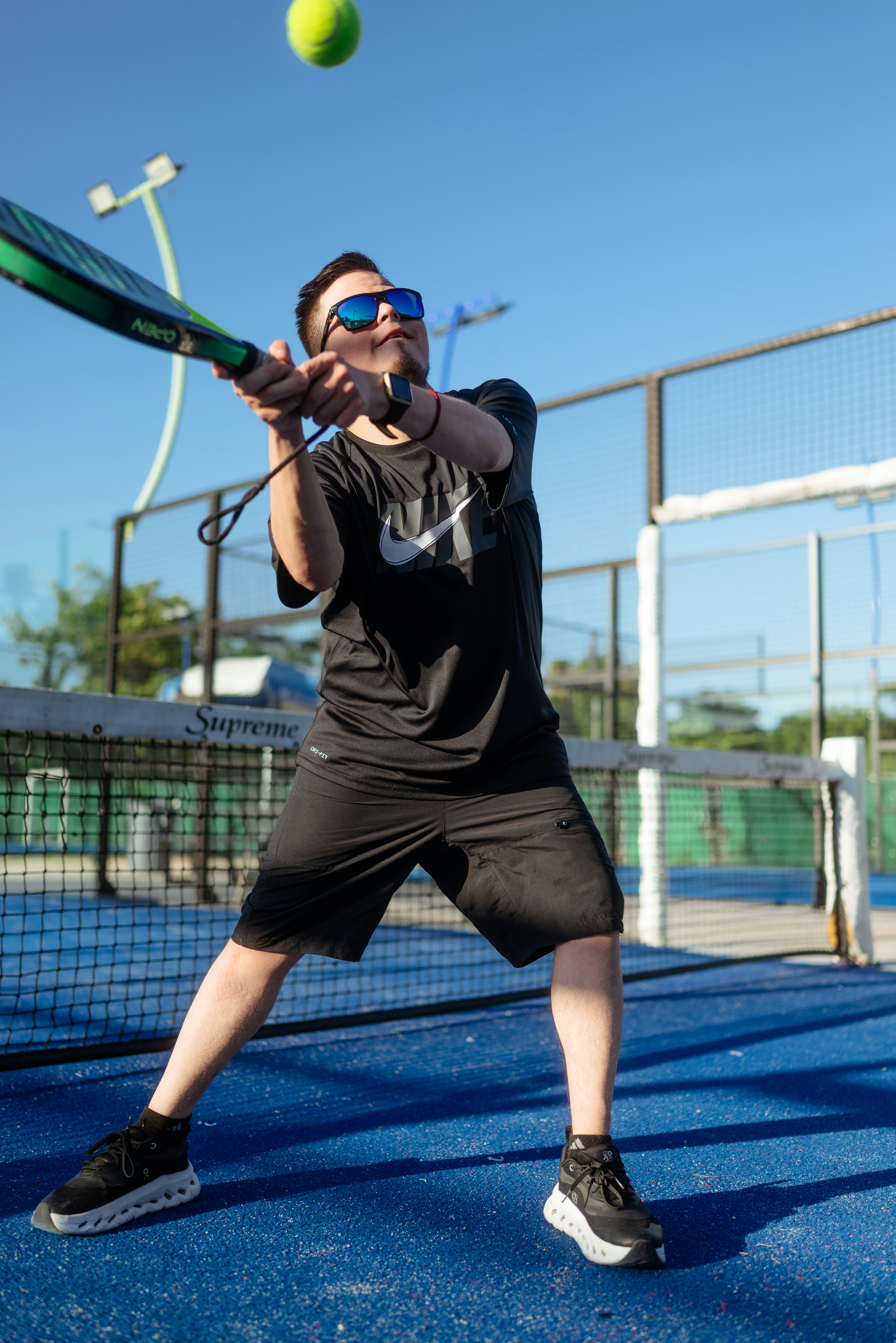 A person plays padel tennis.