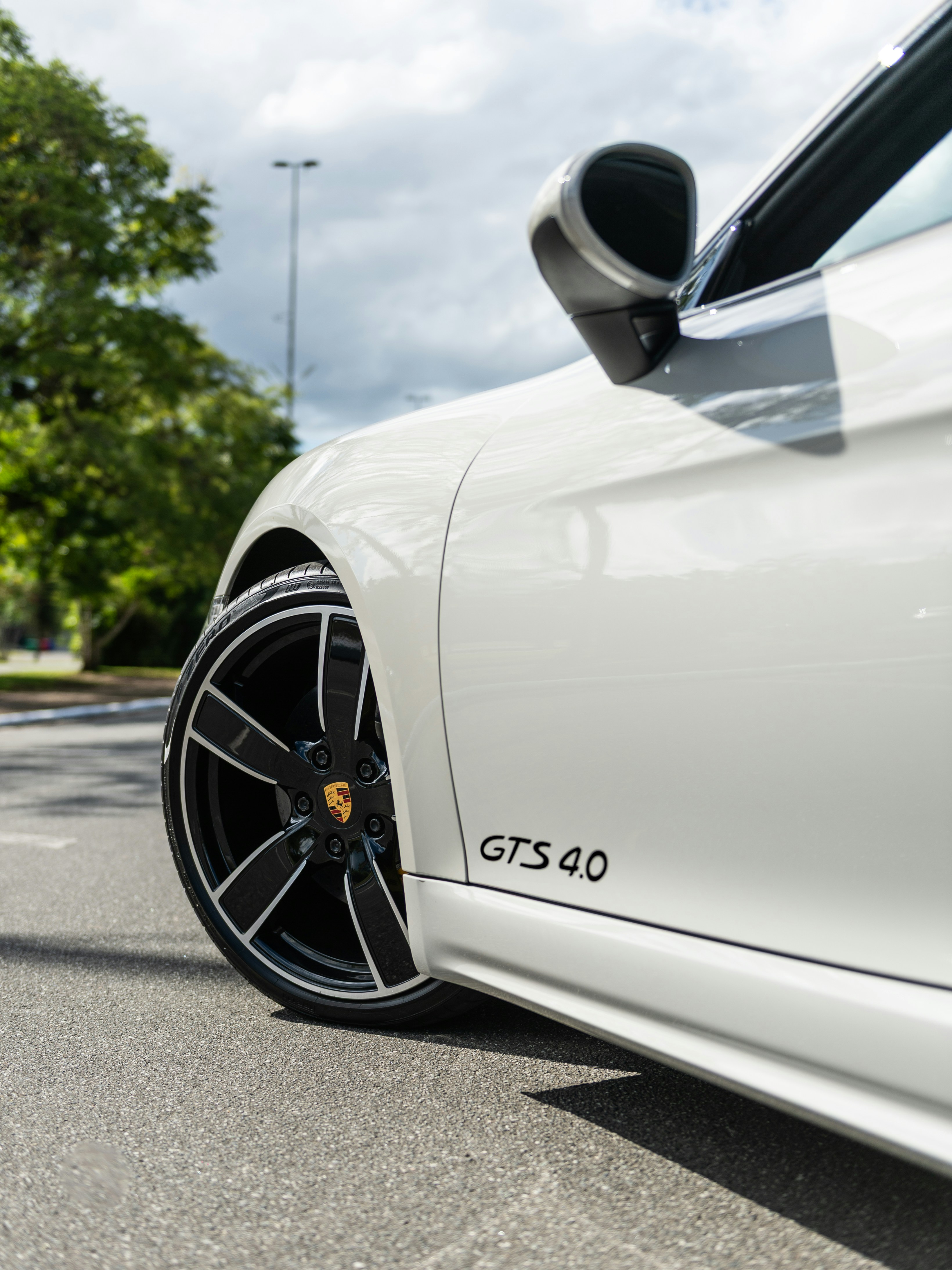 A white porsche gts 4.0 shines in the sunlight.
