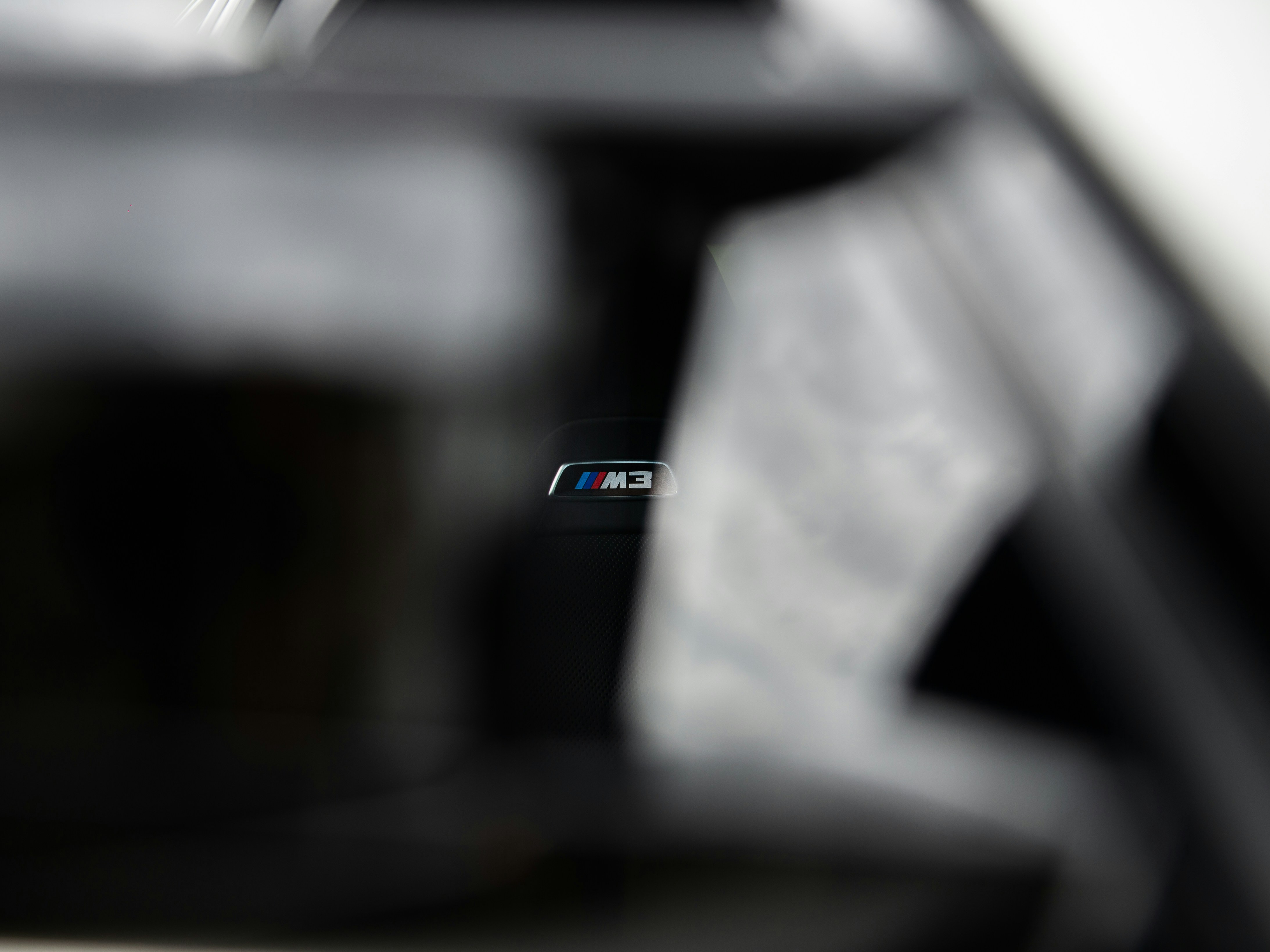 The image features a BMW m badge.