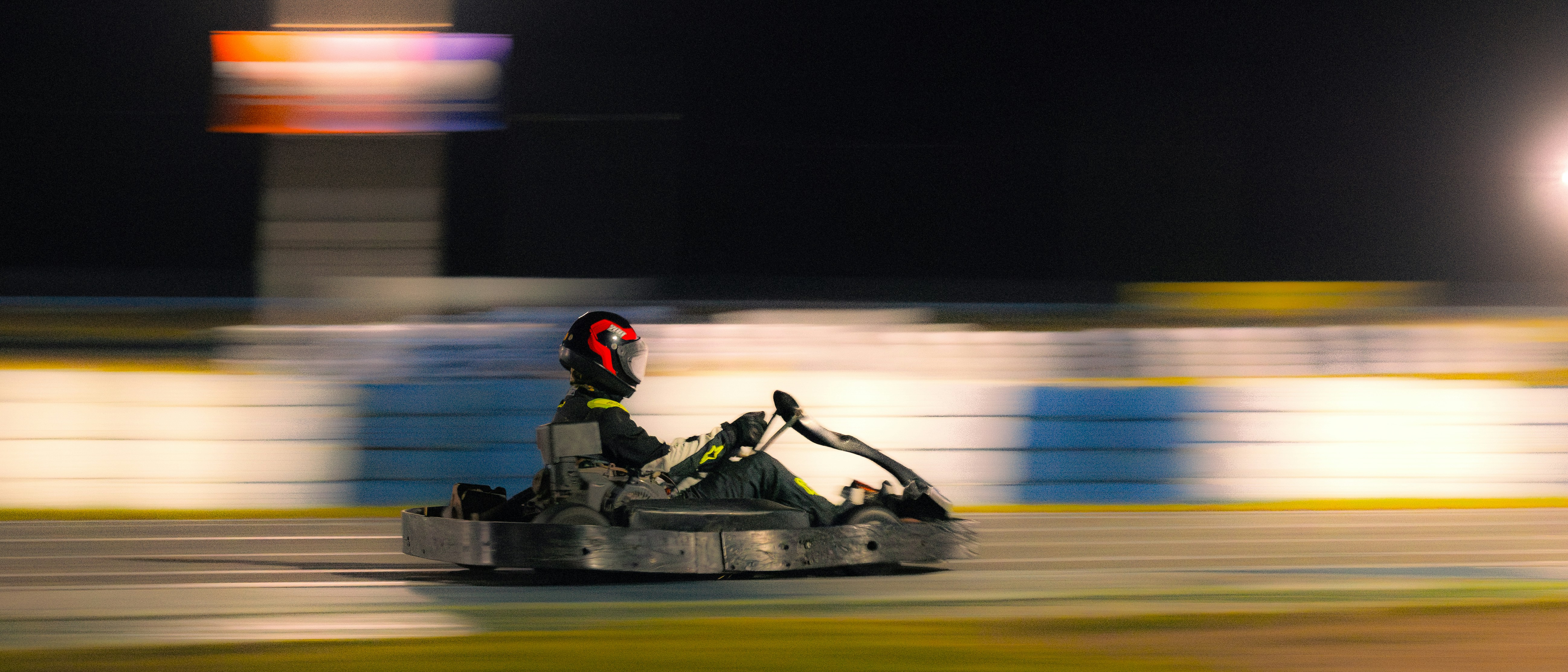 Blurred Velocity: Kart Racing Through Night Lights
