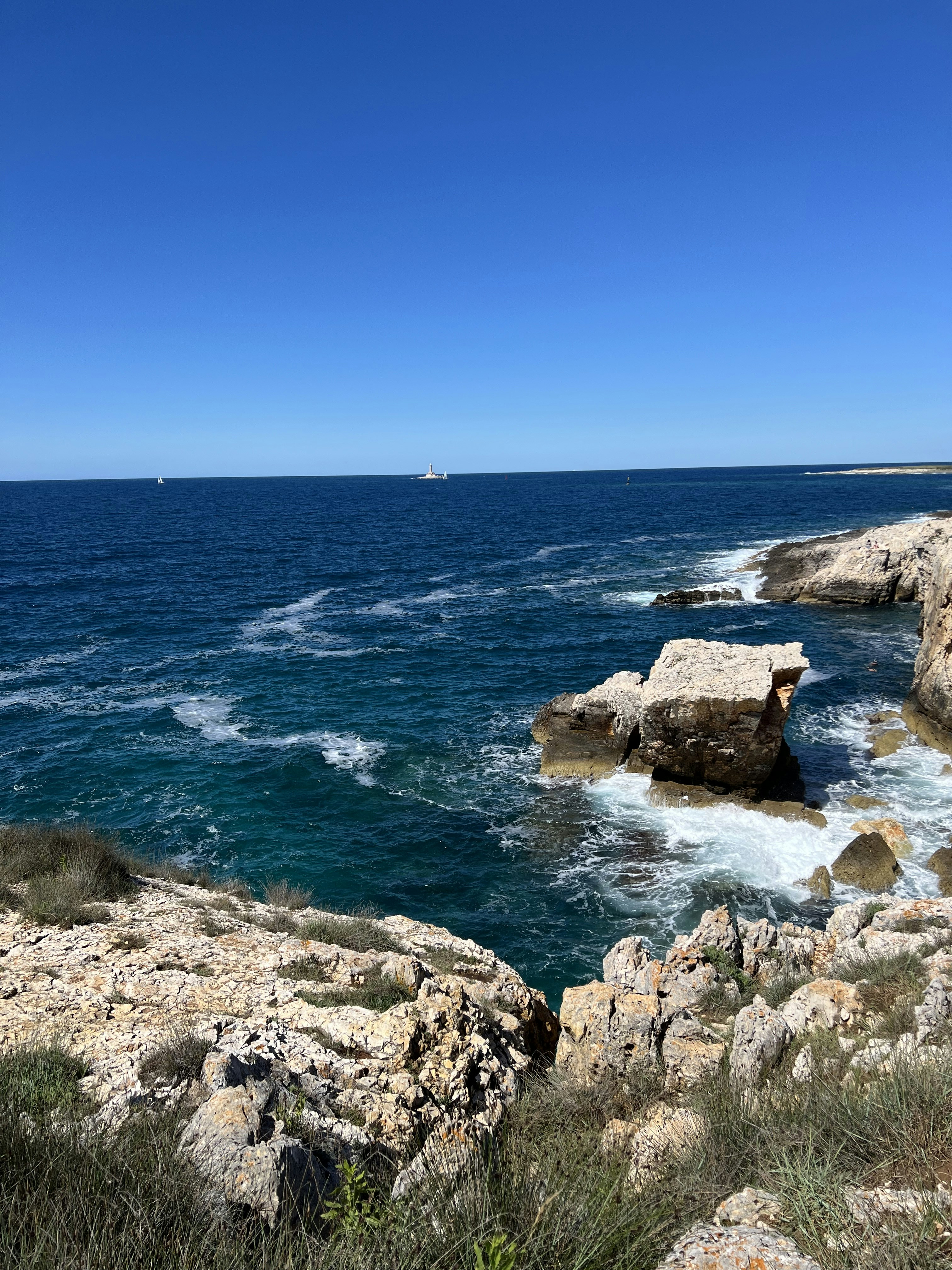 Rocky coastline meets the beautiful, clear ocean.