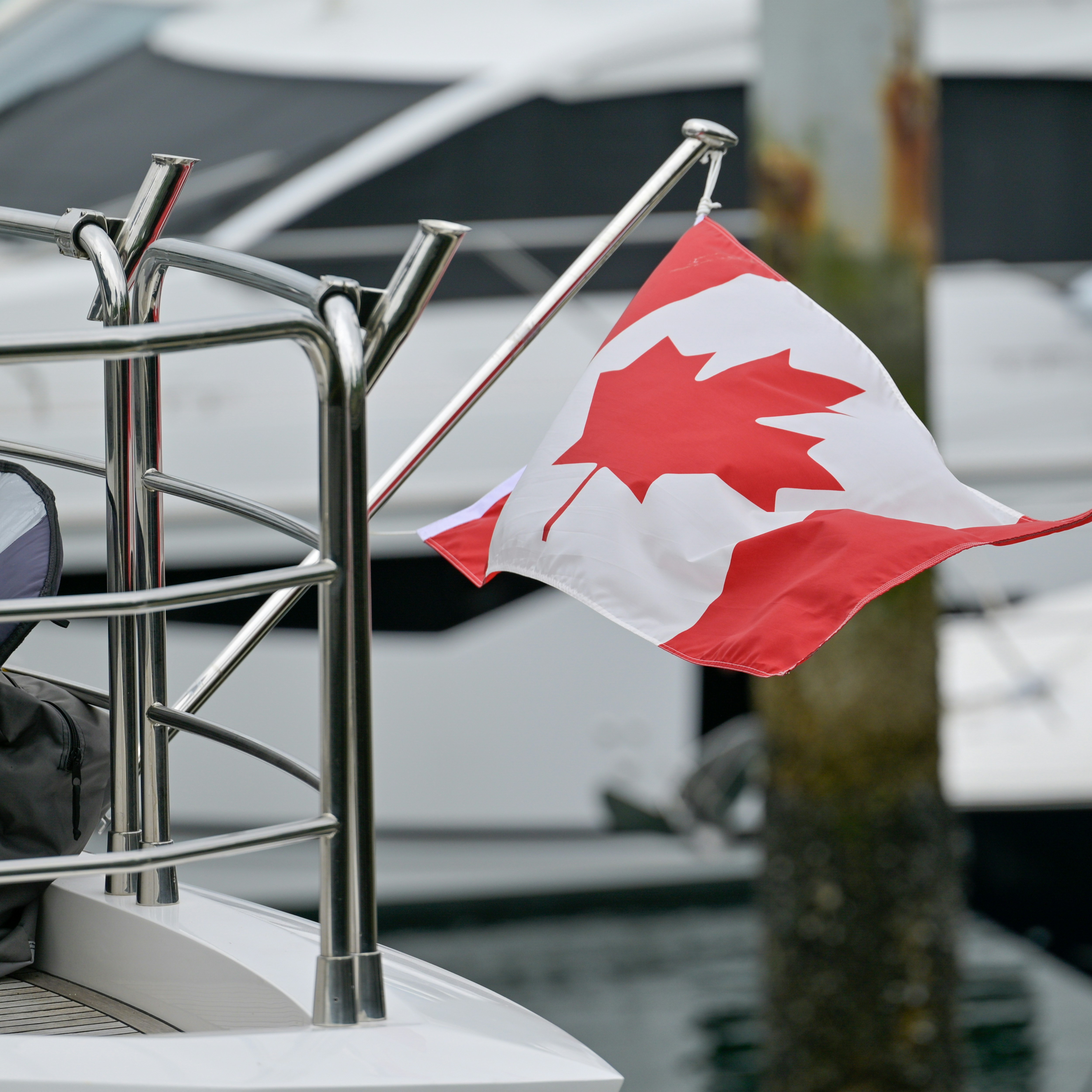 Maple Banner at the Marina Bow: A Canadian Flag in the Breeze