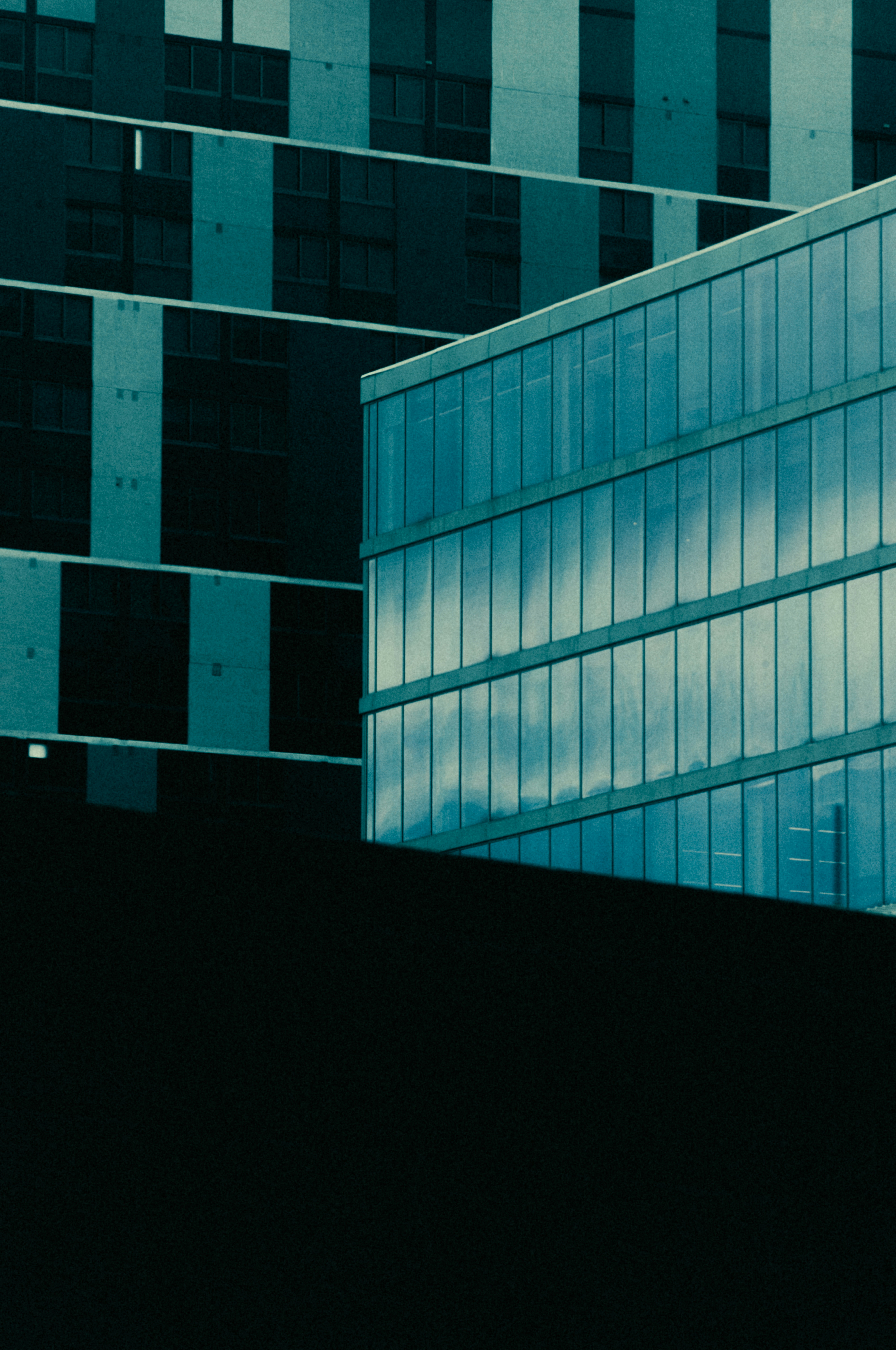 Modern buildings against a dark, empty background.
