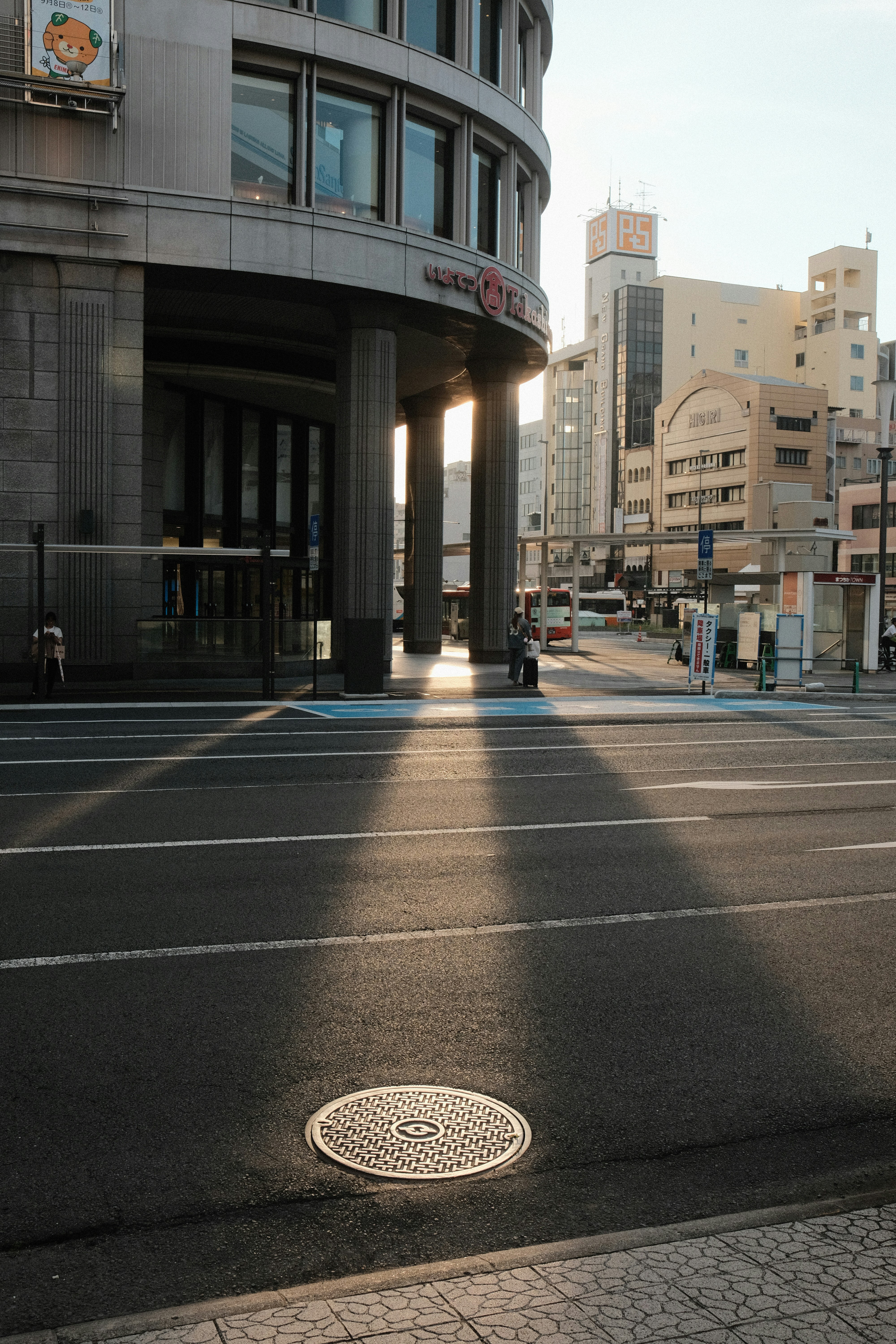Sunlight casts shadows on a city street.