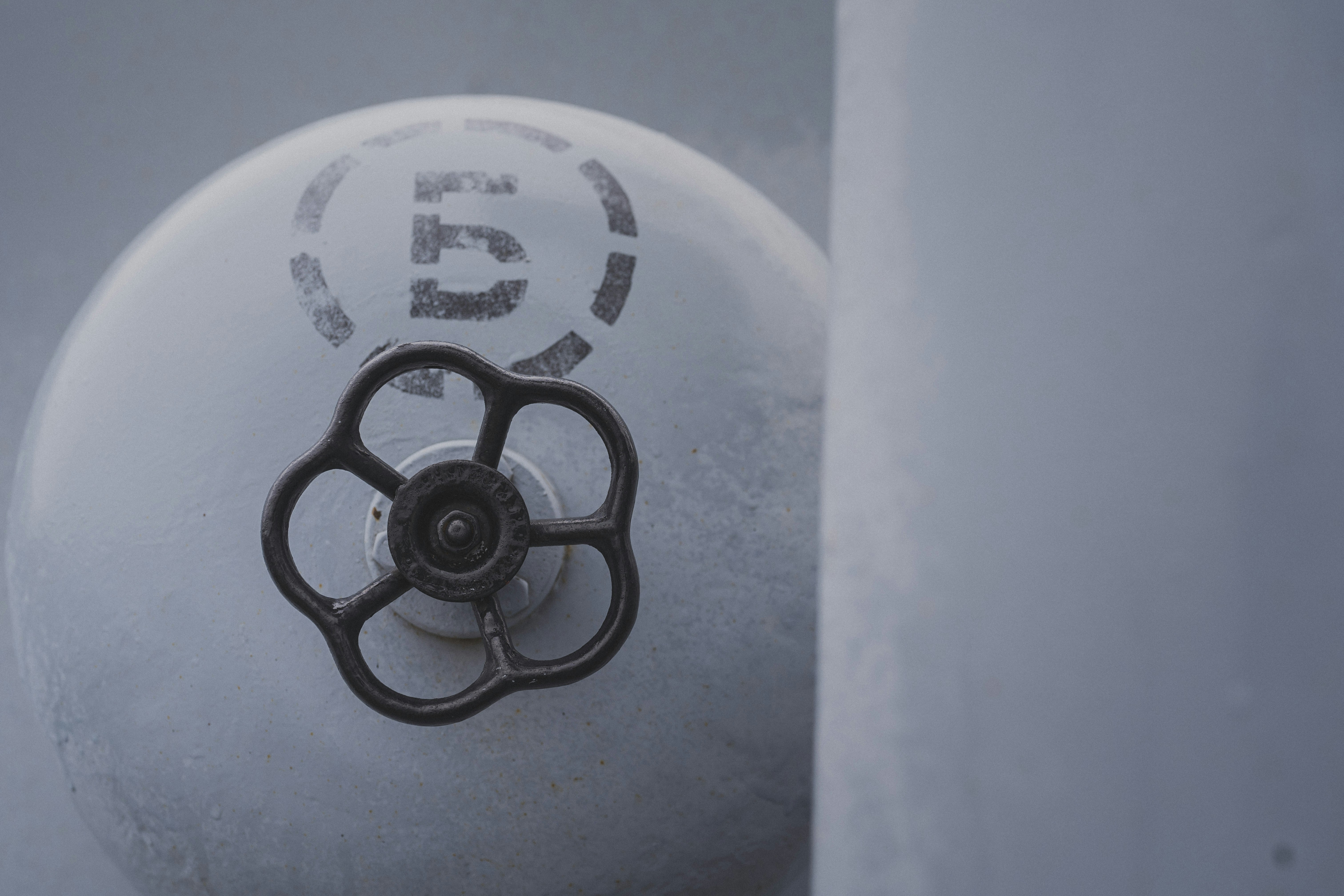 Details of the old Red Pennant (Красный Вымпел) naval vessel from Vladivostok | An industrial tank valve is shown in close-up.