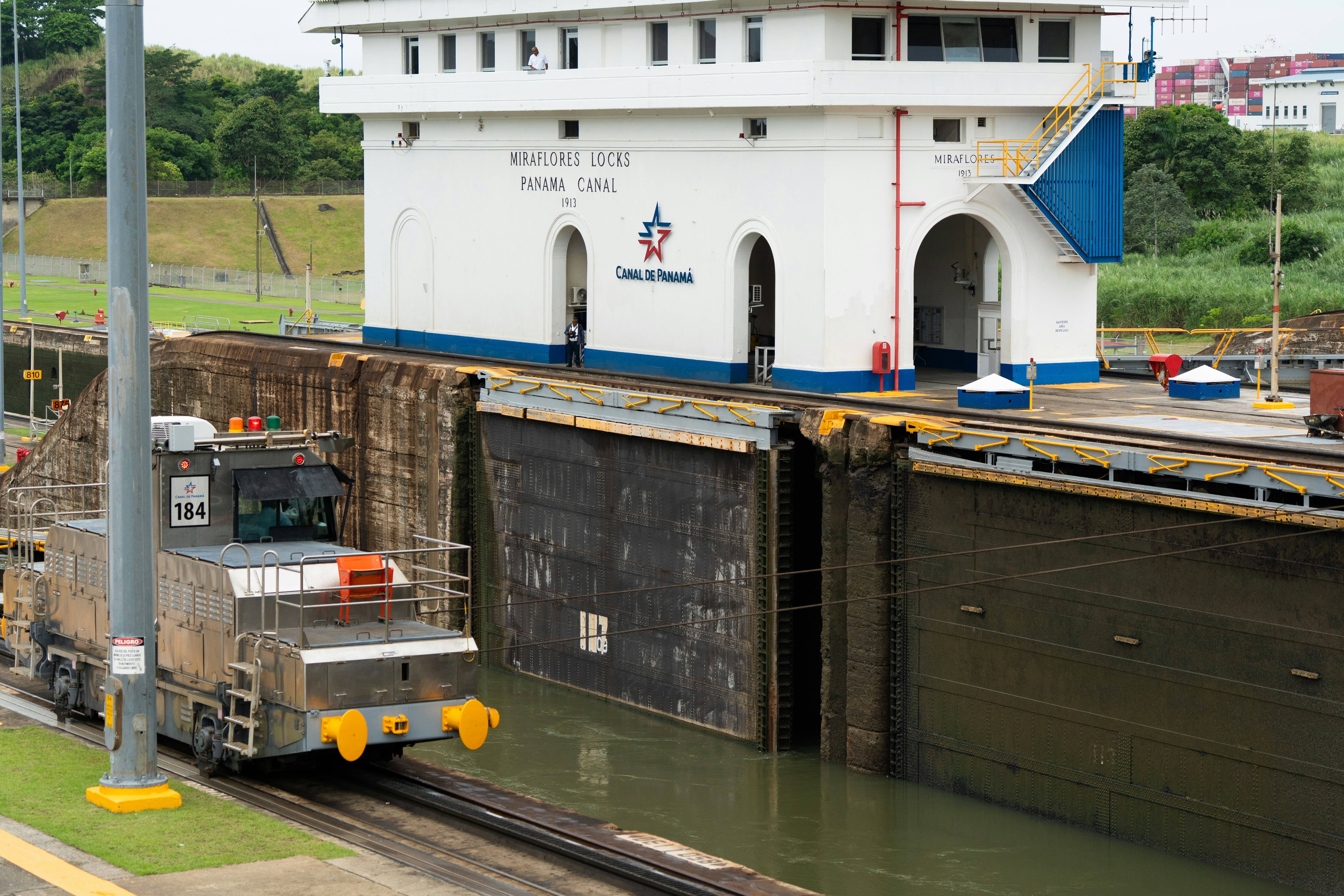 A locomotive maneuvering through the Miraflores Locks of the Panama Canal, showcasing the intricate engineering of this vital waterway.