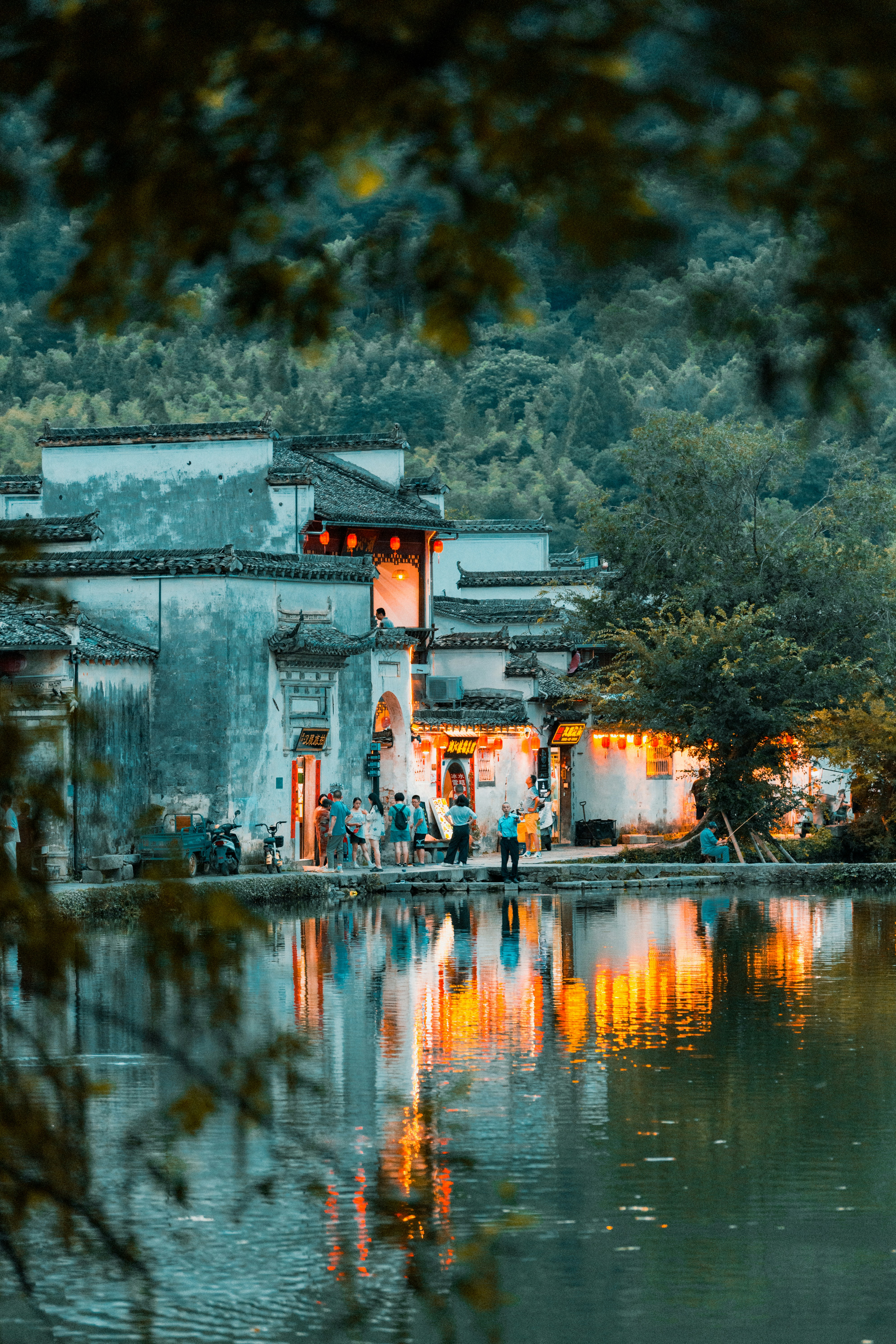 Chinese Ancient Village | Historic village reflects in a tranquil lake.