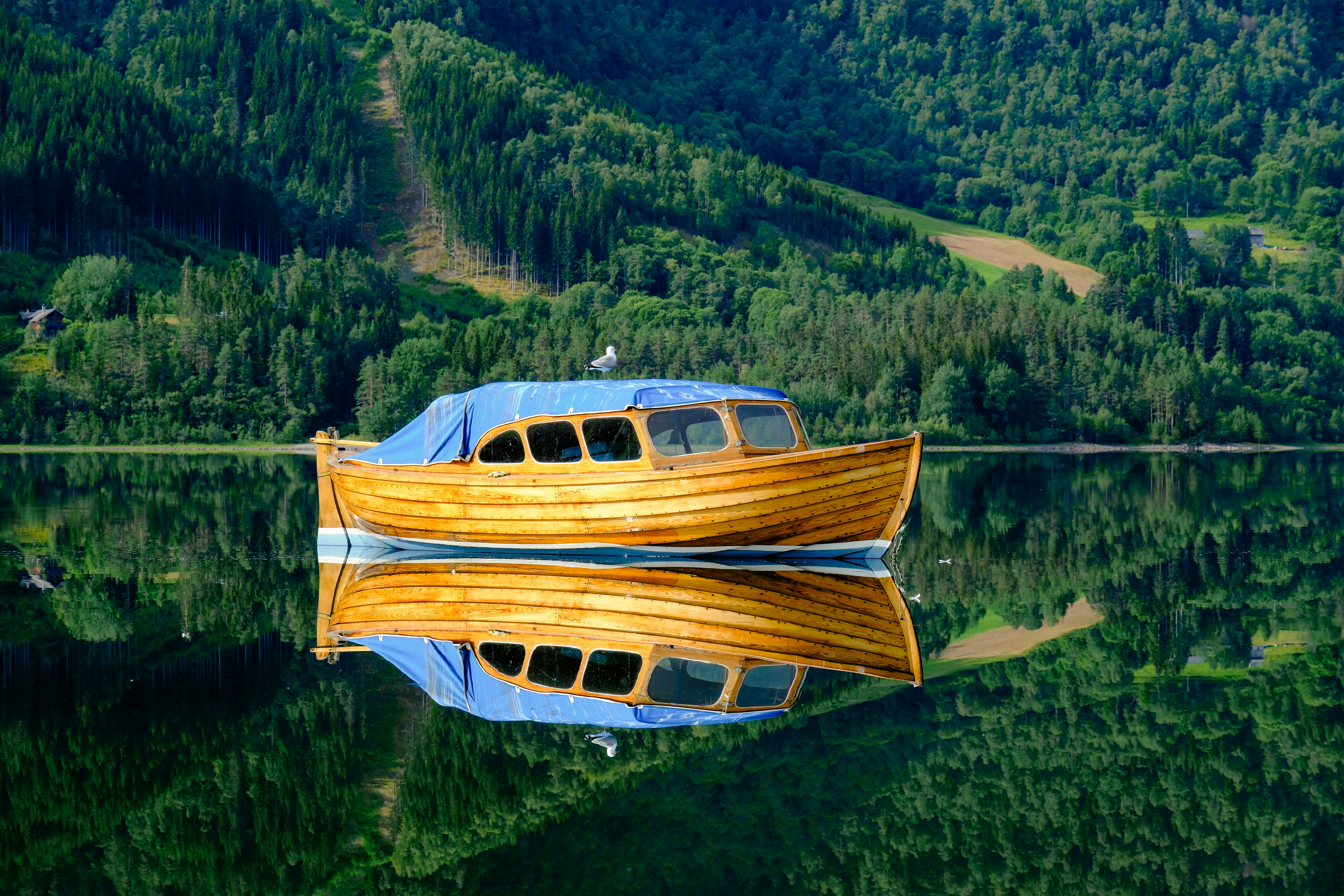 Wooden boat floats peacefully on a lake.