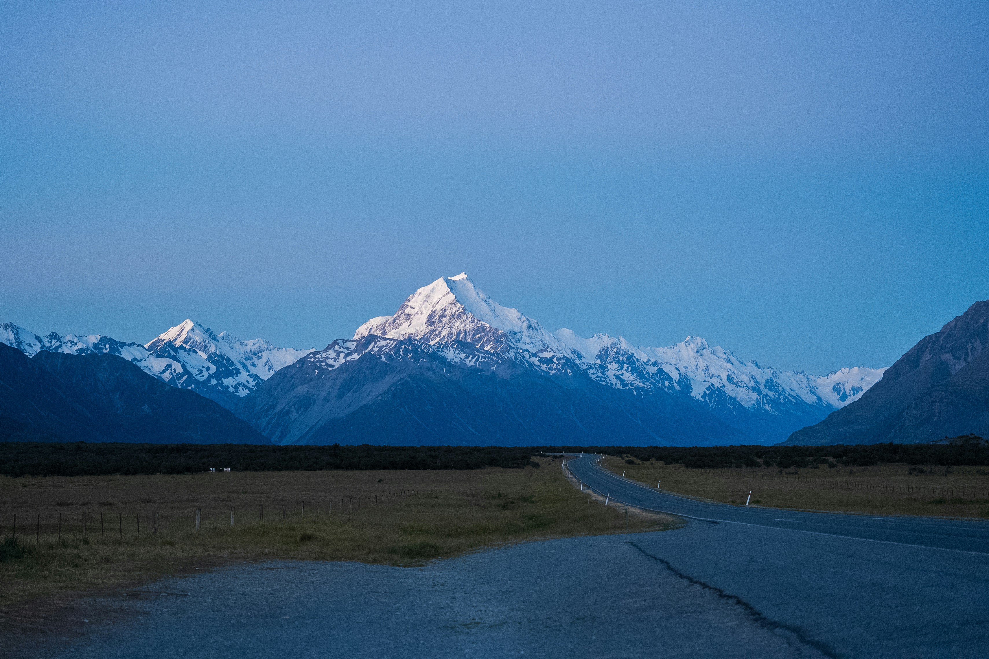 Snow‑kissed Peak Guarded by an Open Road