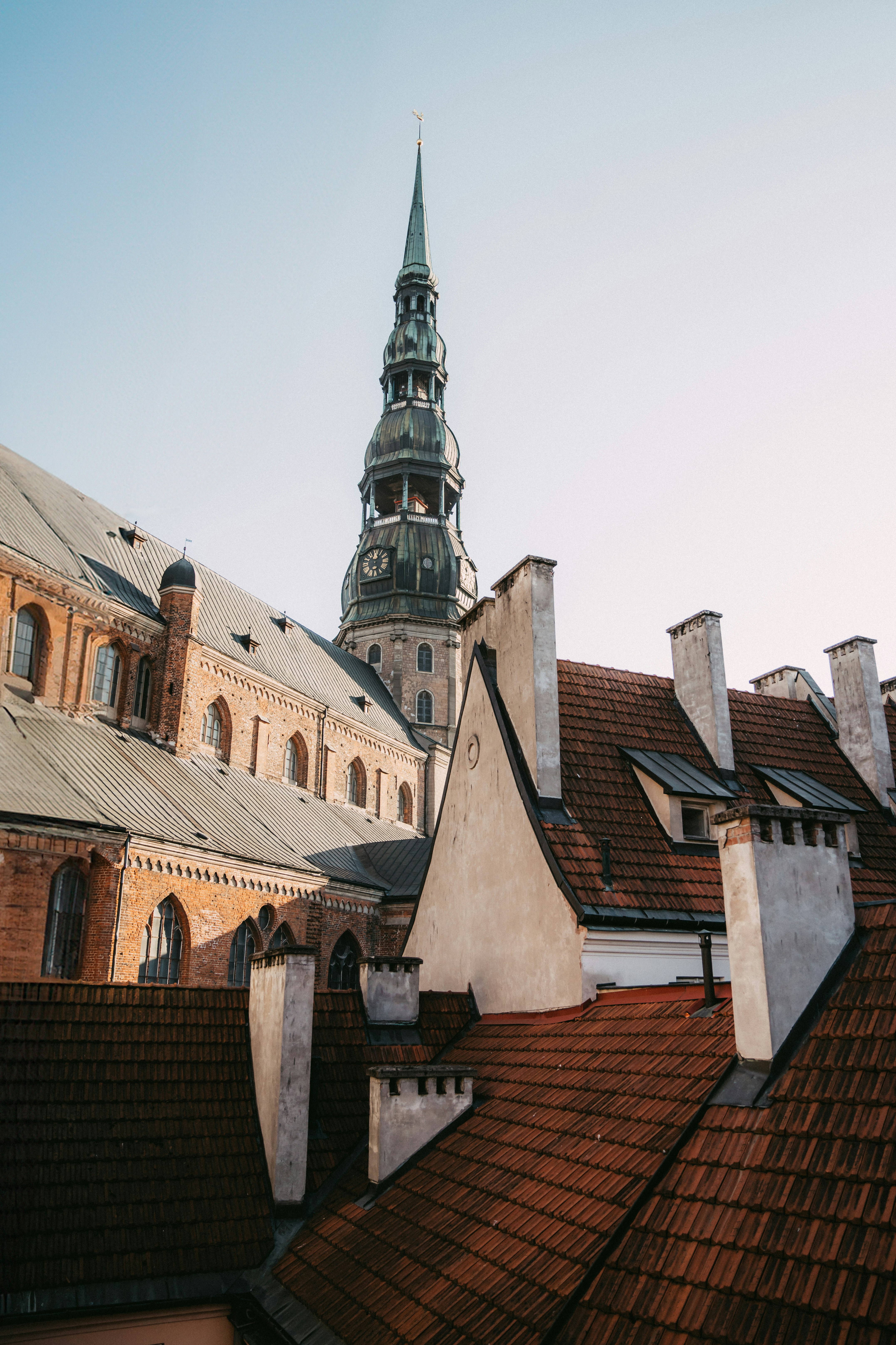 A church spire towers above the rooftops. photo – Free Building Image ...