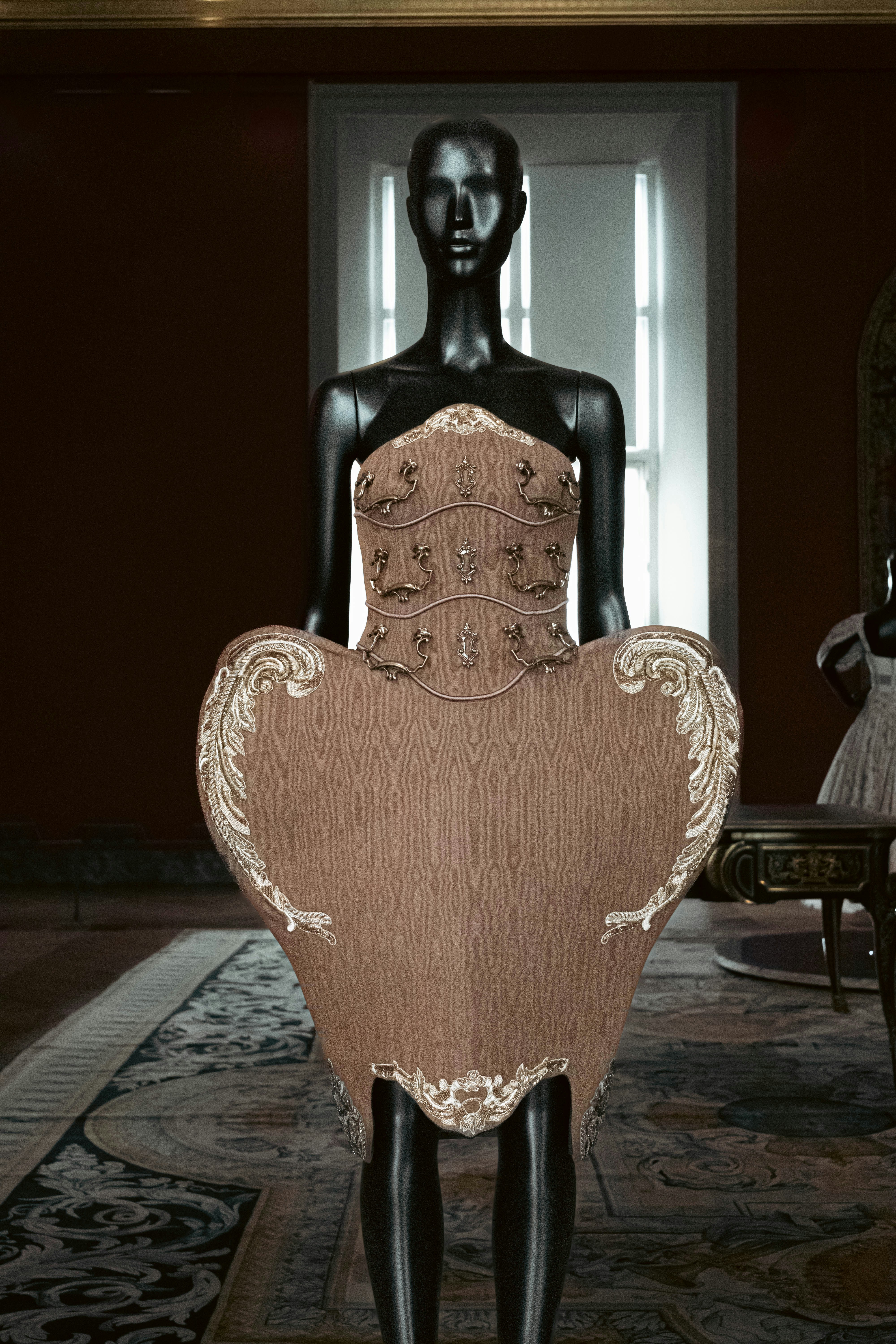 Embroidered Echo: A Corset's Sculpted Silhouette in a Dim Gallery