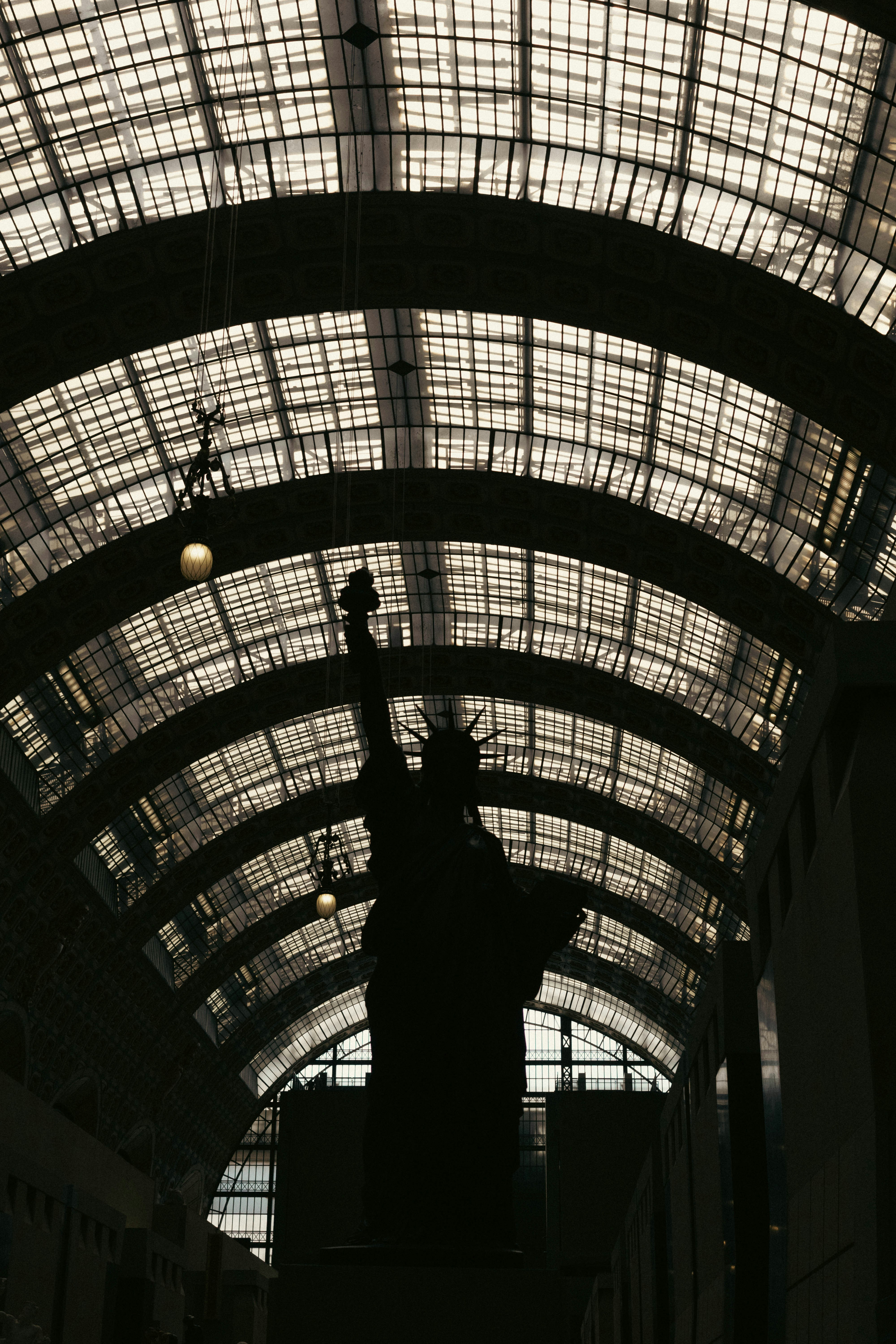 Silhouette of Freedom Beneath an Architectural Canopy