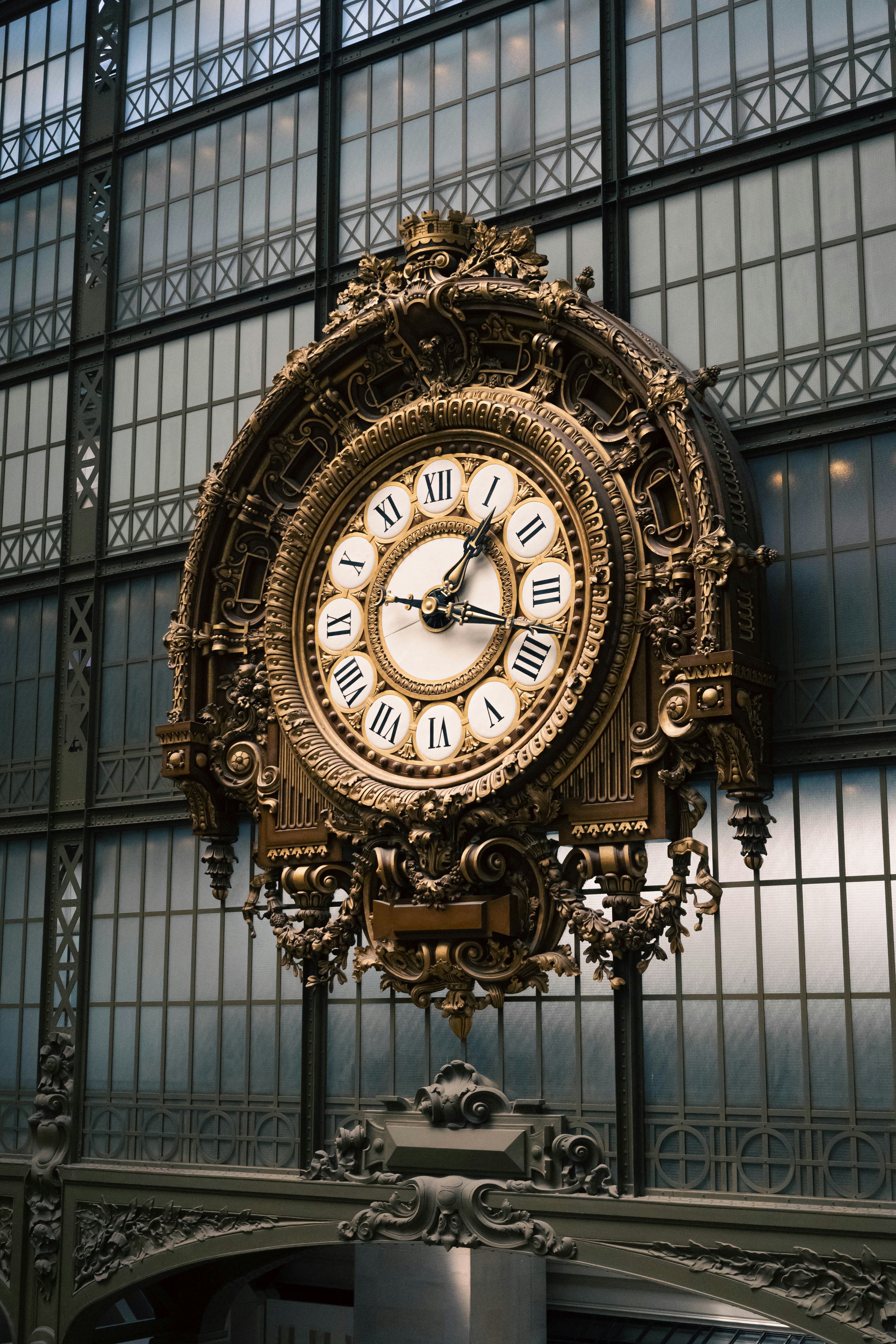 Gilded Timekeeper under a Glass Atrium