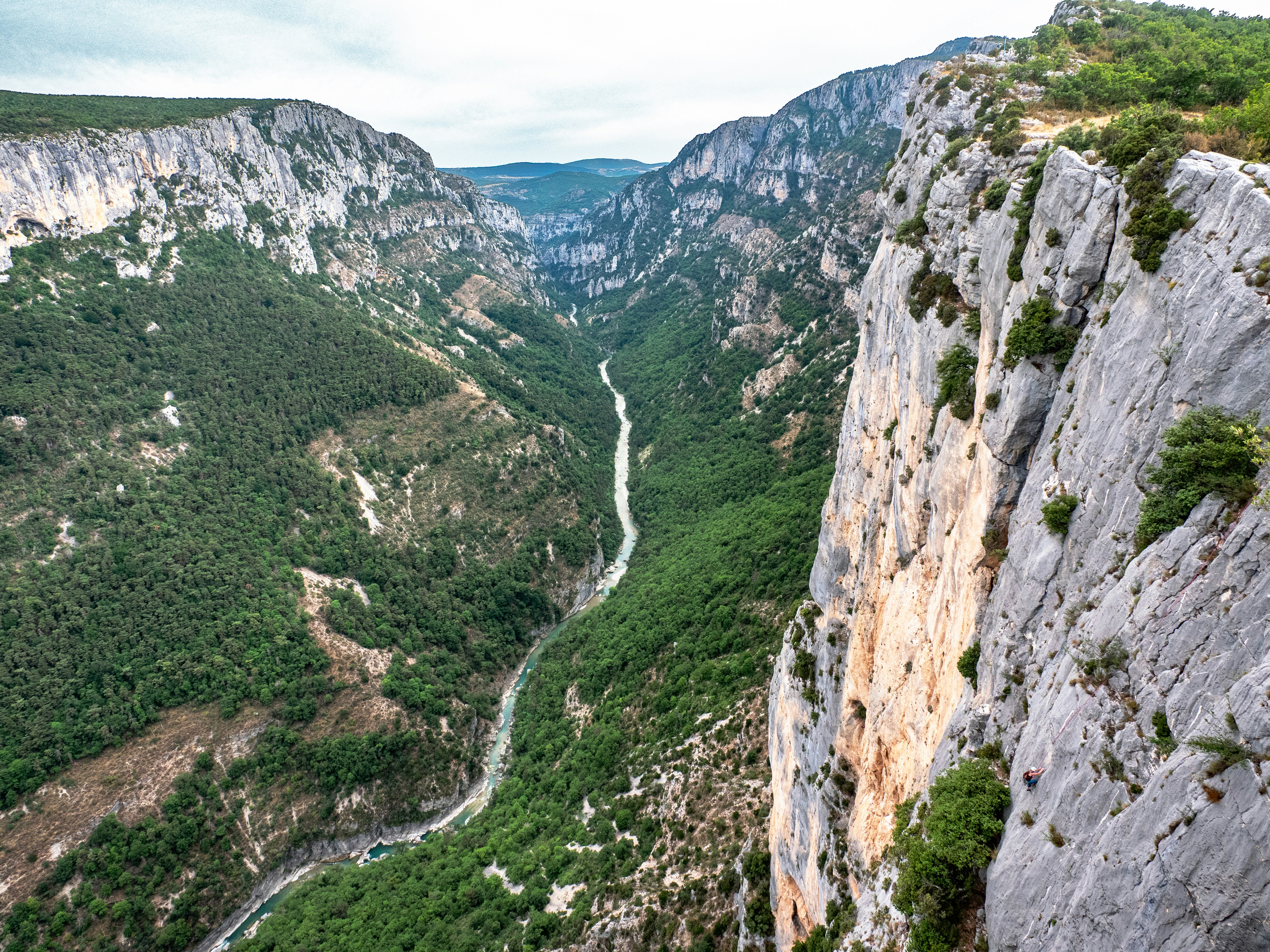 A scenic canyon with a river running through it.