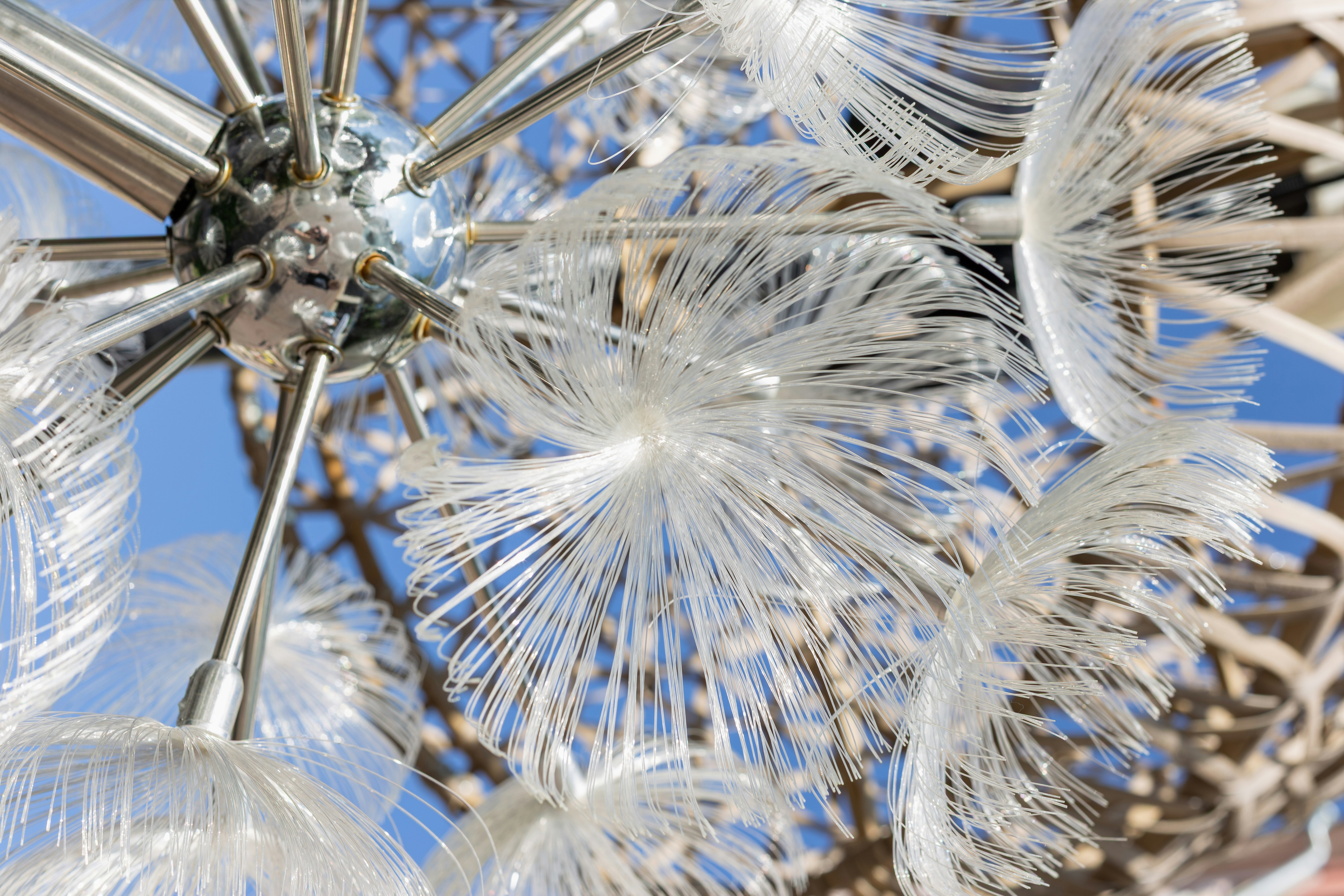 Metal structure with wispy, transparent orbs.