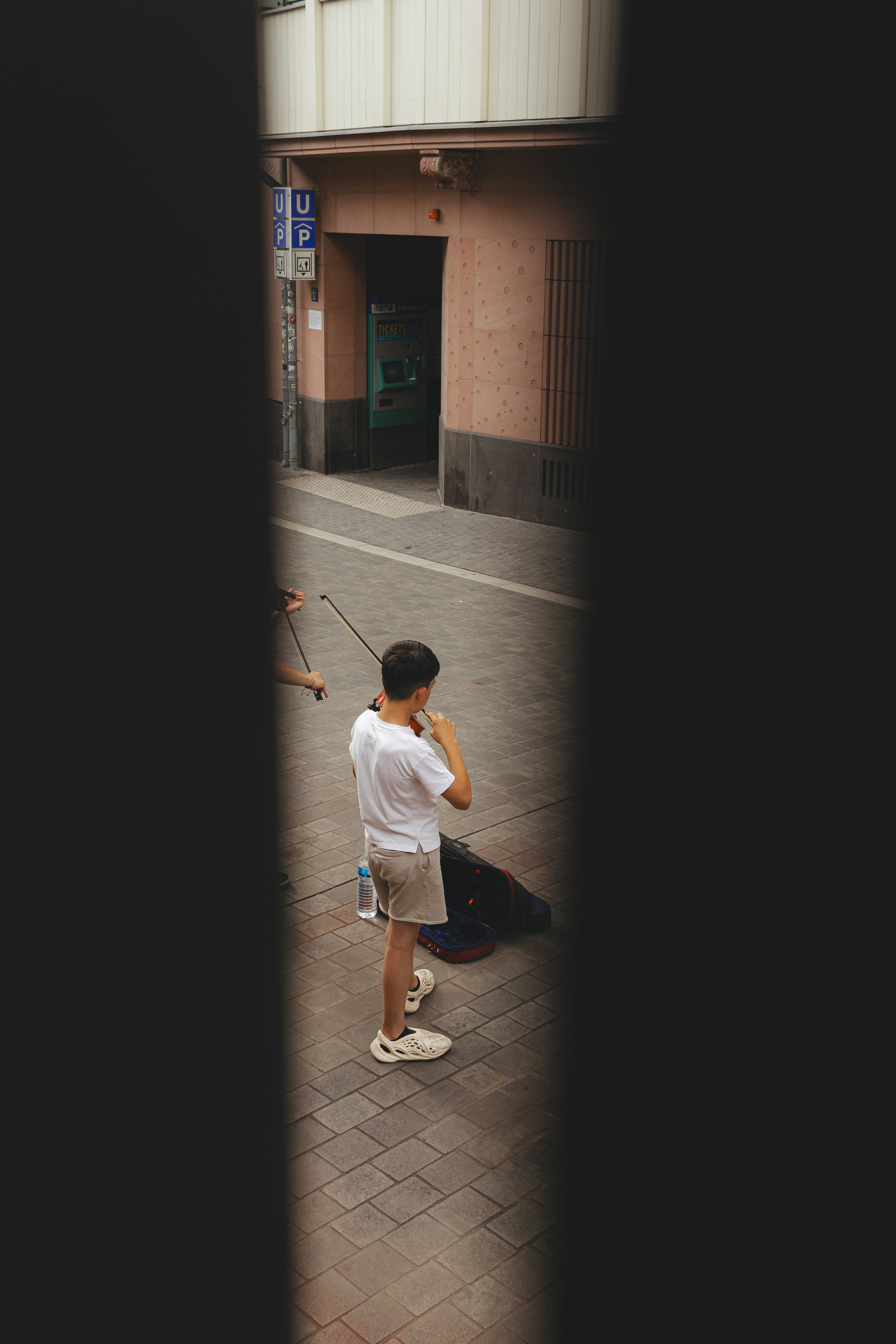 A man stands in a city alley.