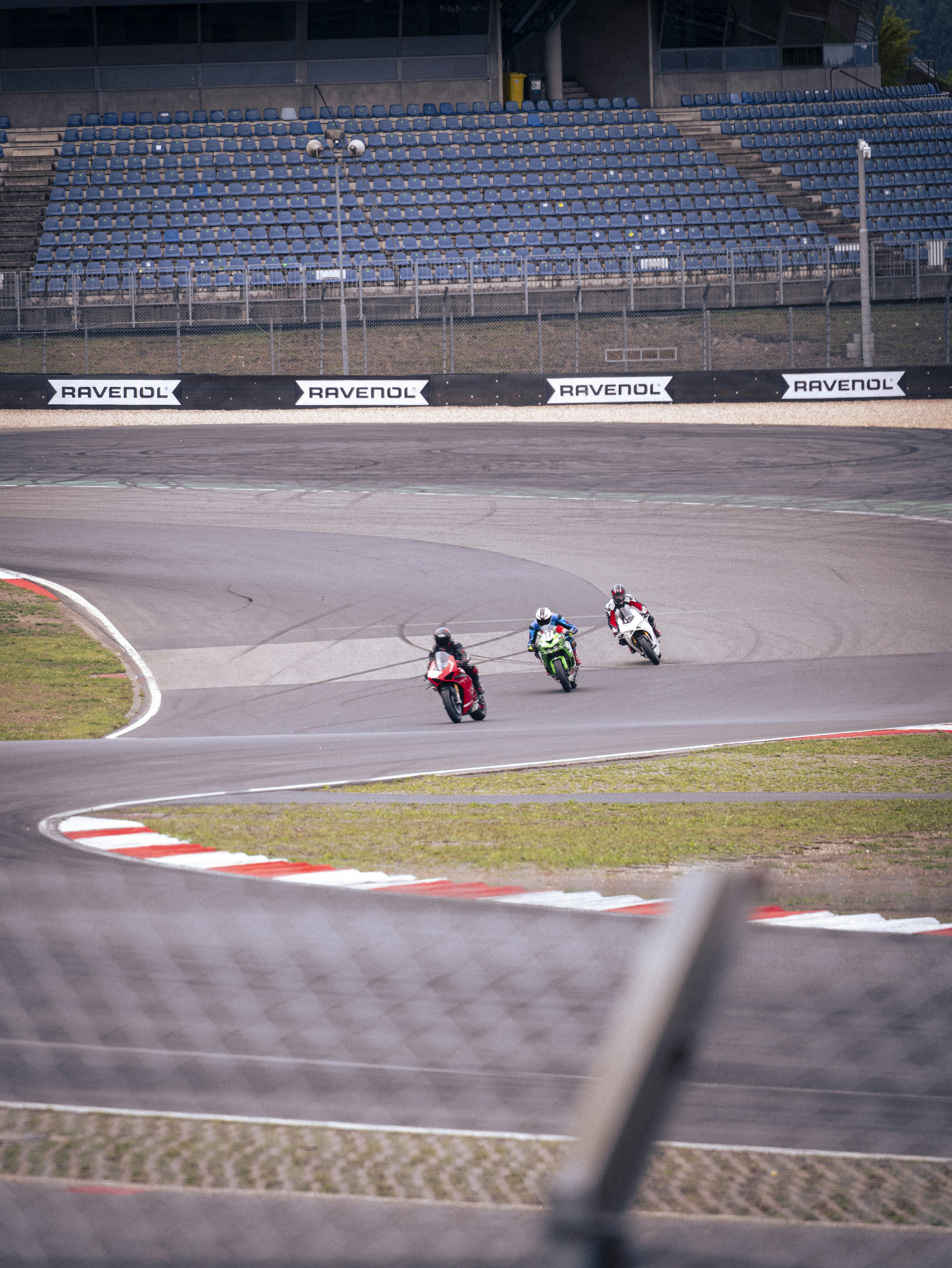 Apex Pursuit at Ravenol Raceway: Trio of Bikes Lean Through the Curve