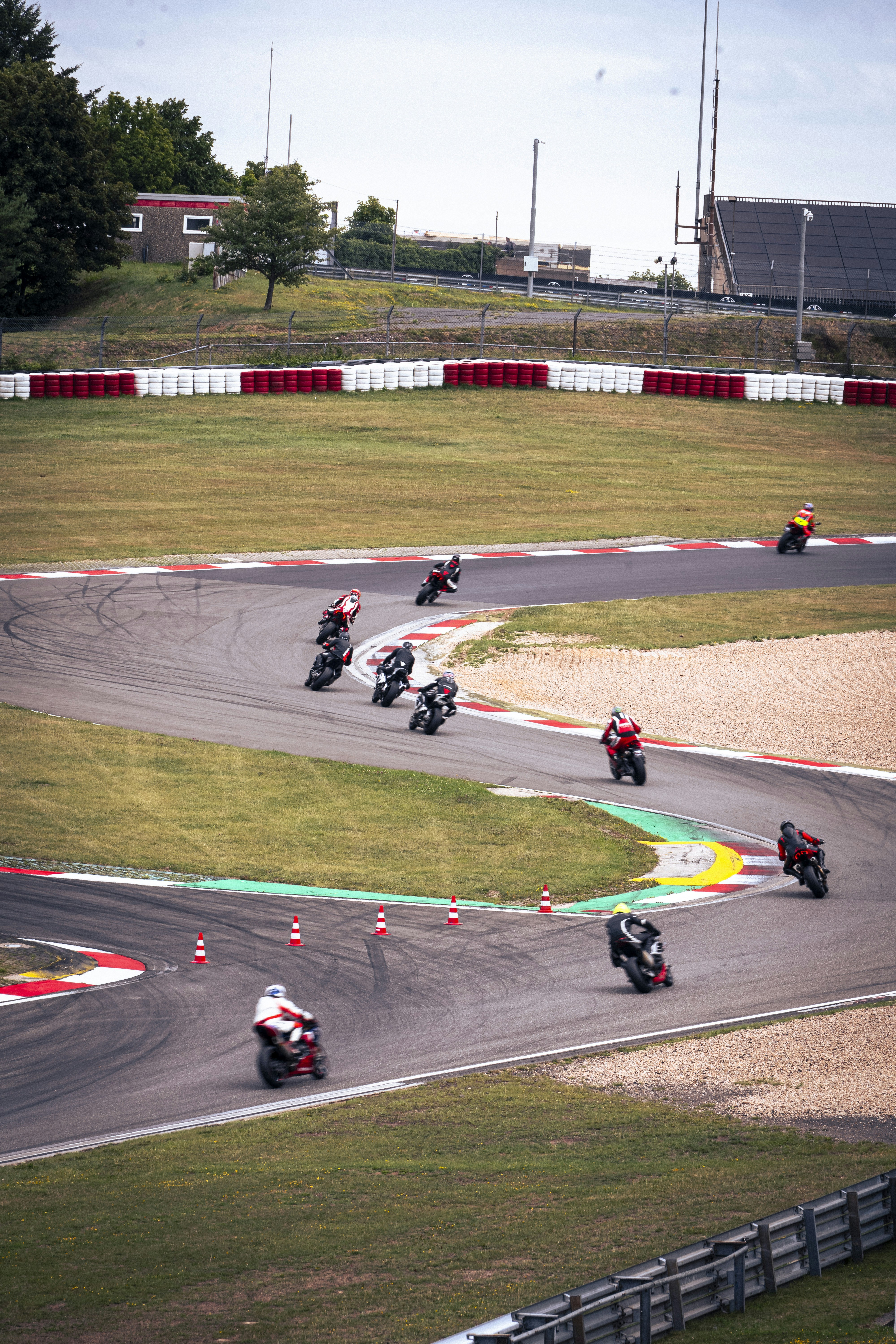 Motorcycles race around a curved racetrack. photo – Free Motorbike ...