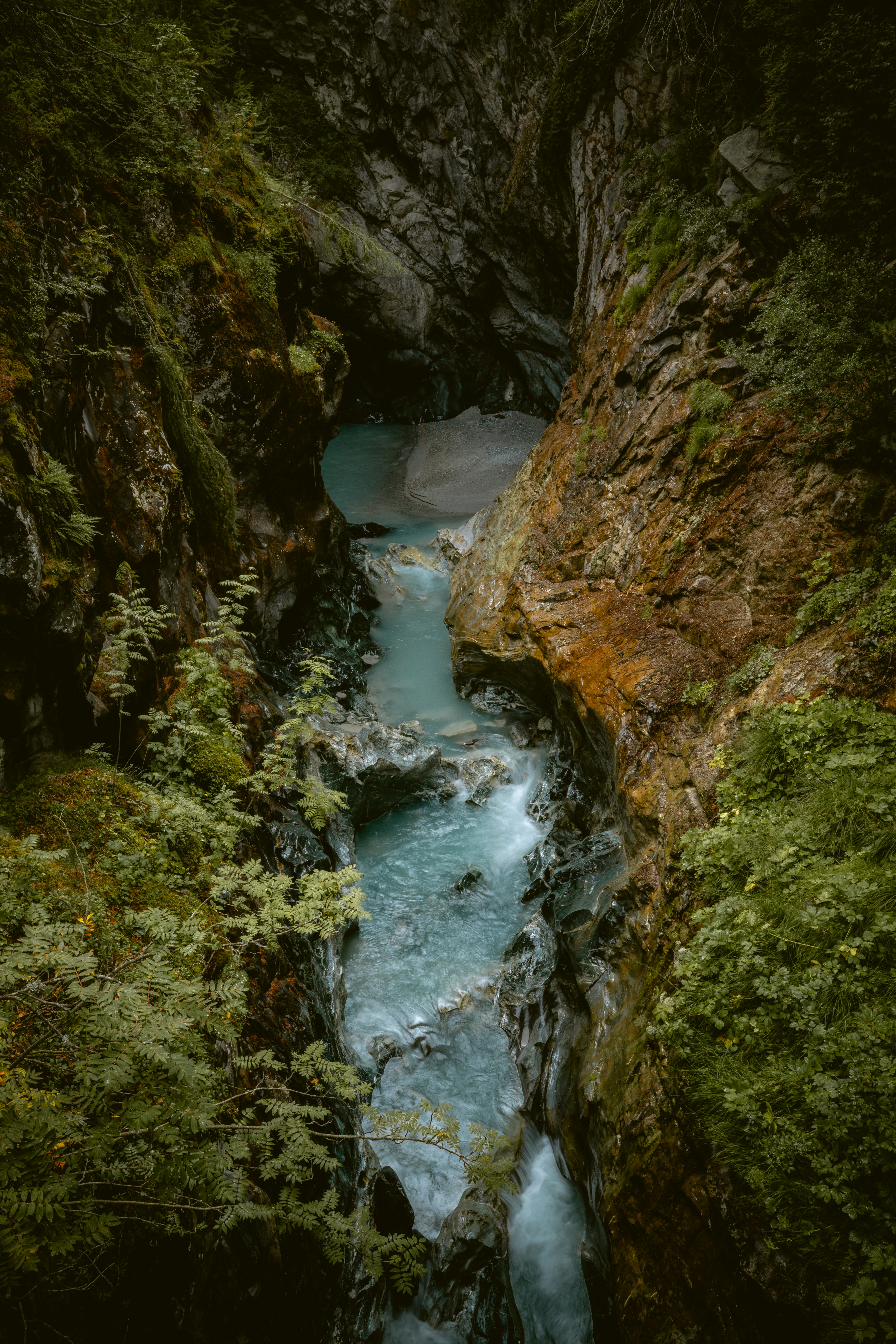 A river cuts through rocky mountains.