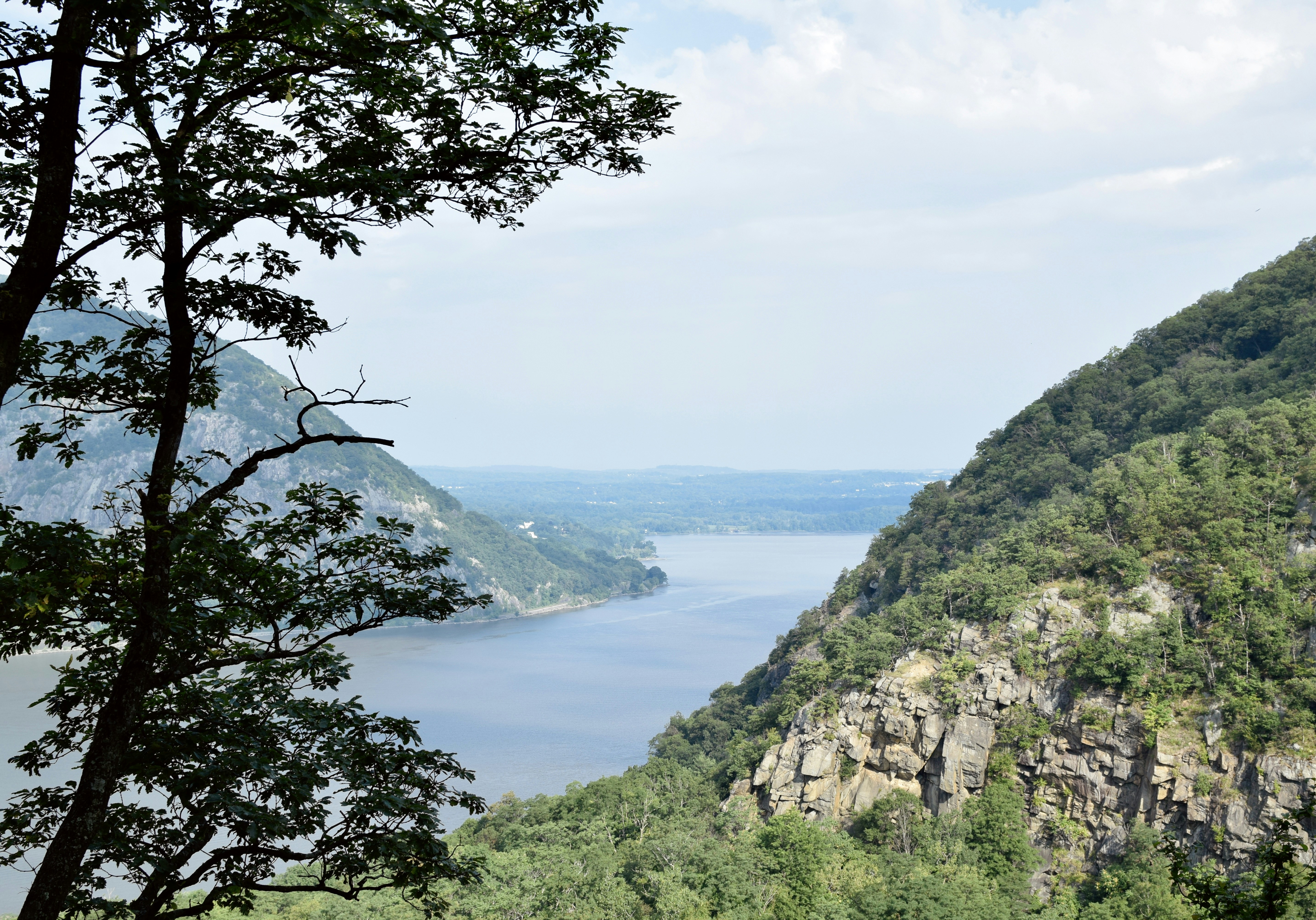A scenic river flows between lush green mountains.