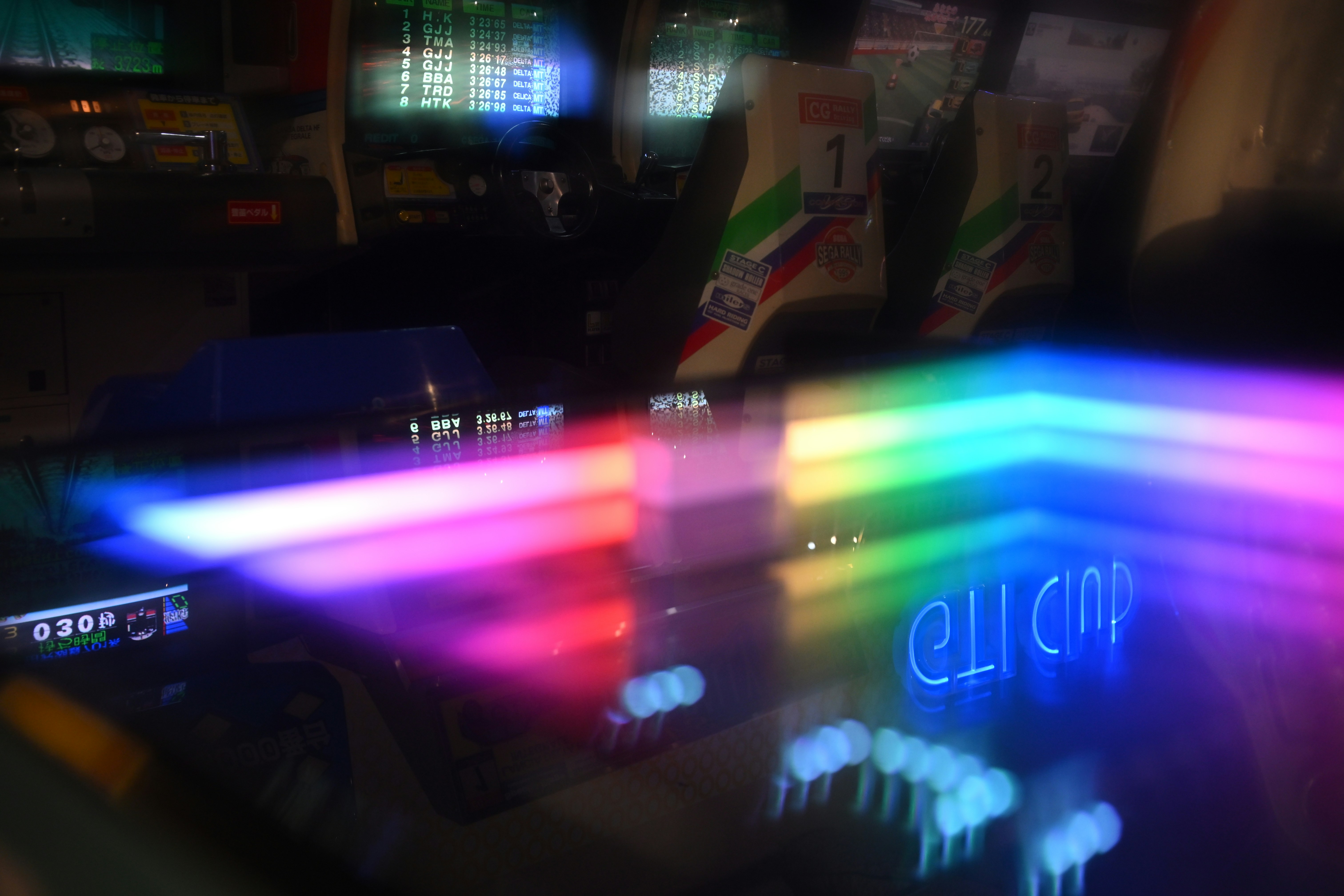 Blurred image of a neon arcade machine.
