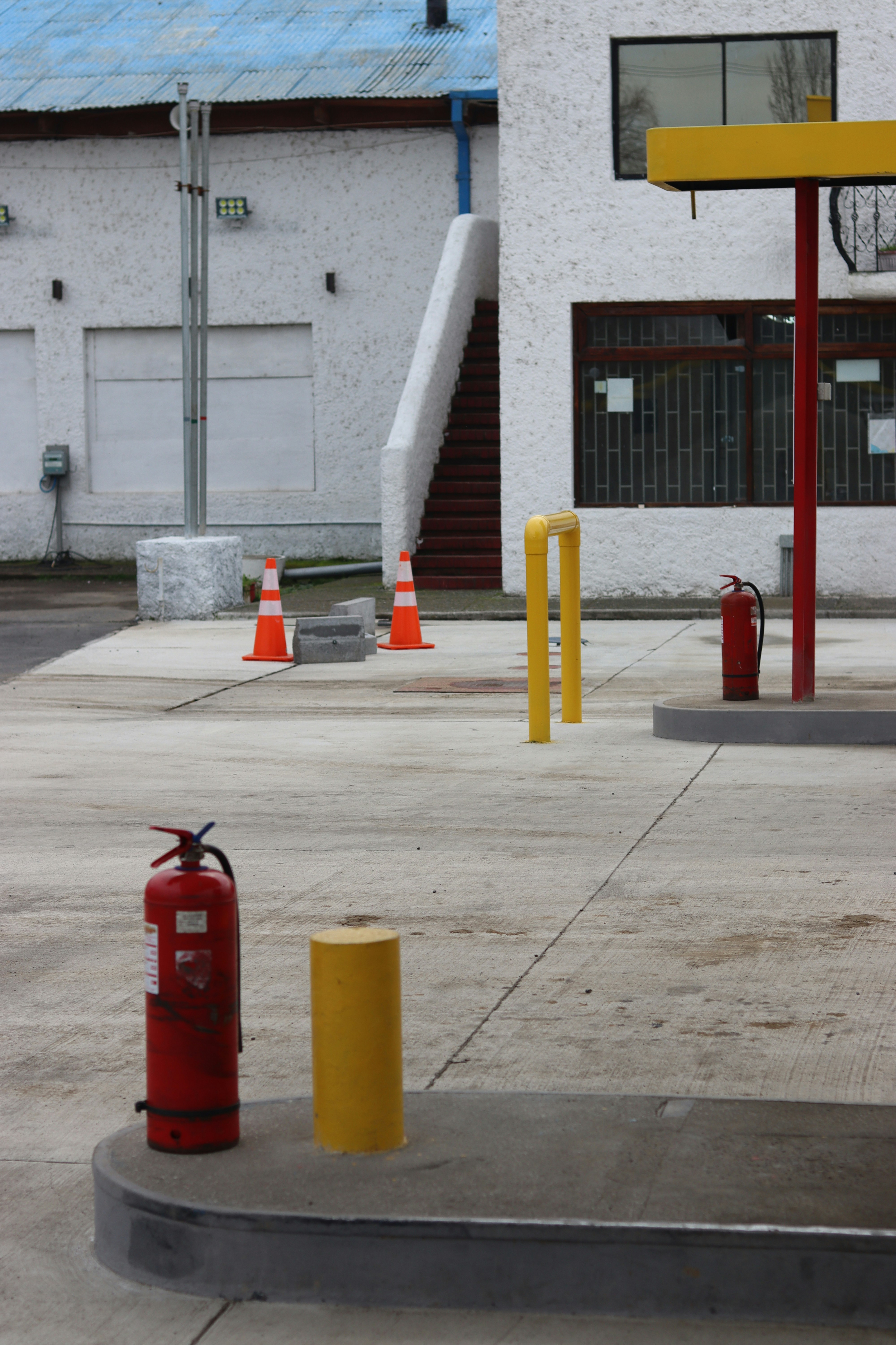 A gas station with fire extinguishers and safety equipment.