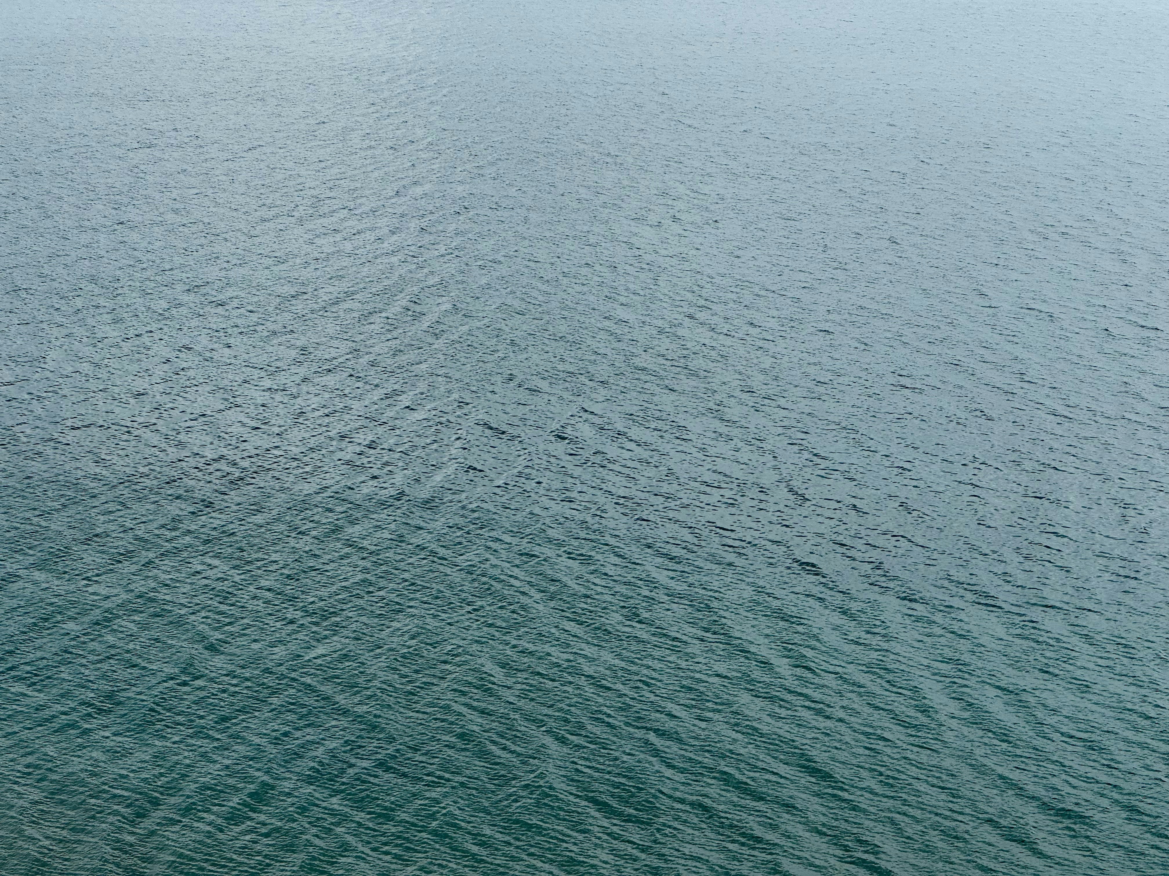 An overhead view of Lake Michigan. | Water surface with subtle ripples.