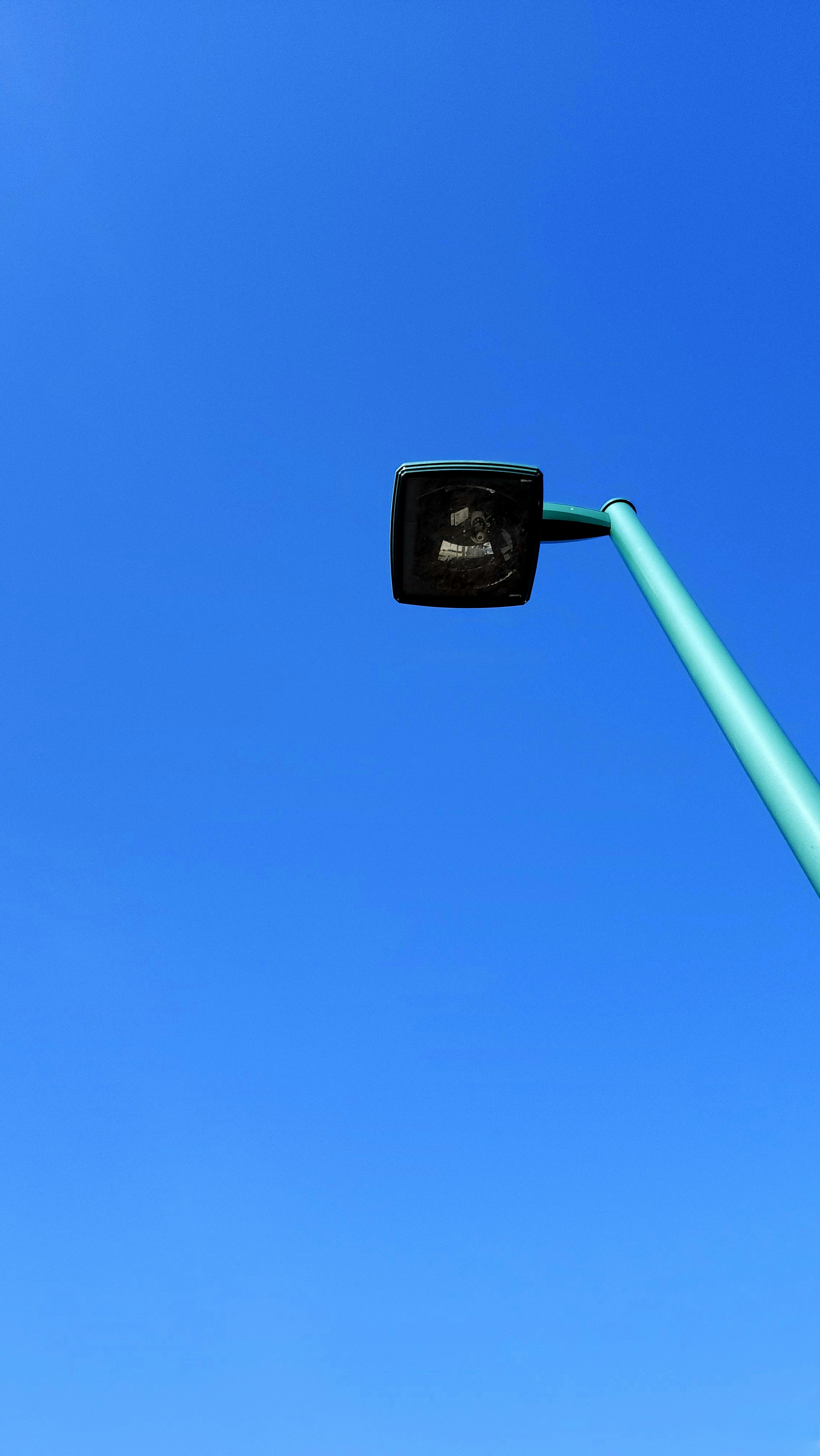 Streetlight Against Blue Sky | A street lamp against a blue sky.