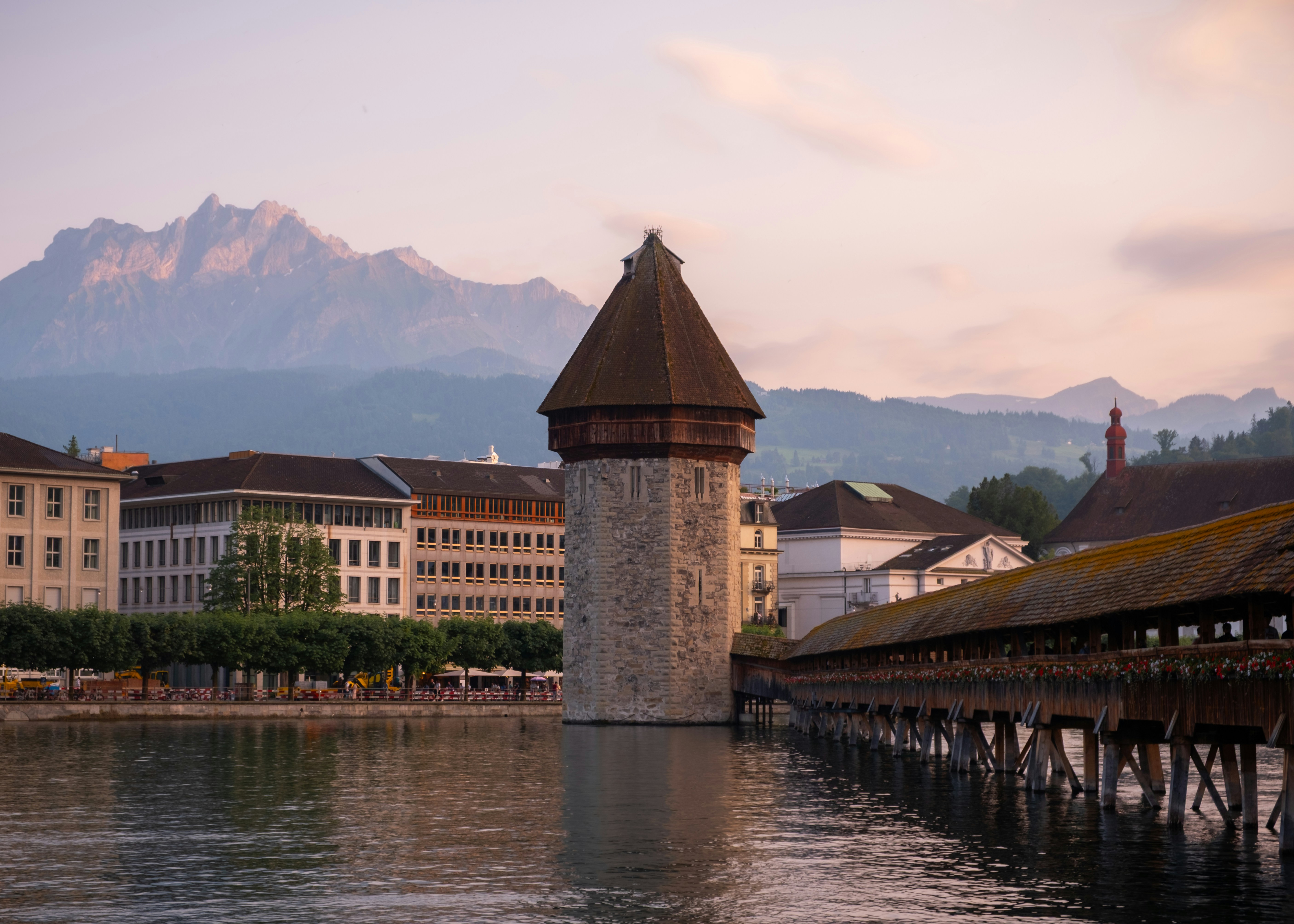 The Lucerne Kapellbrücke with Mount Pilatus in the background | The chapel bridge and water tower at sunrise.