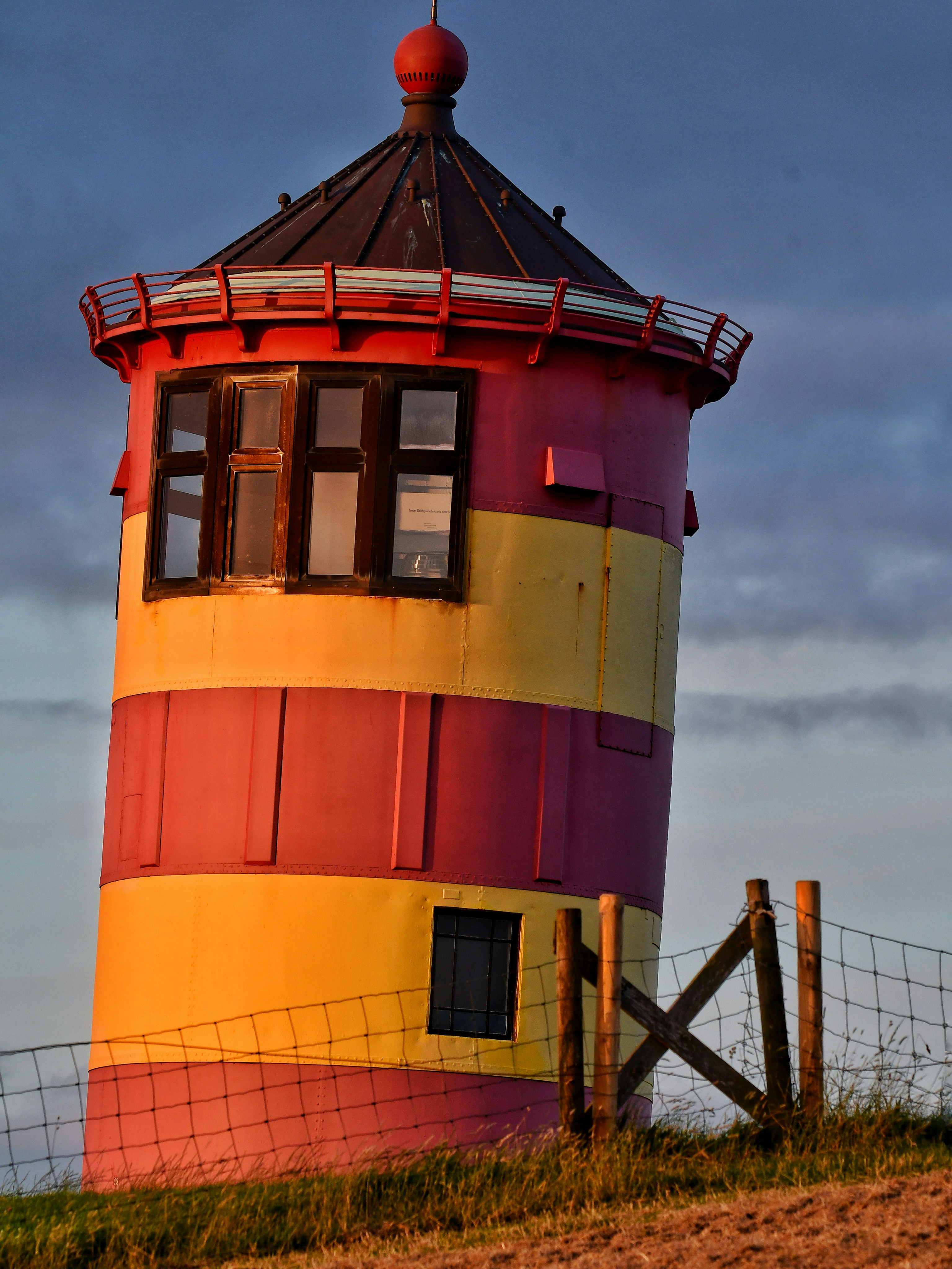 The Colorful Sentinel: A Lighthouse at Dusk