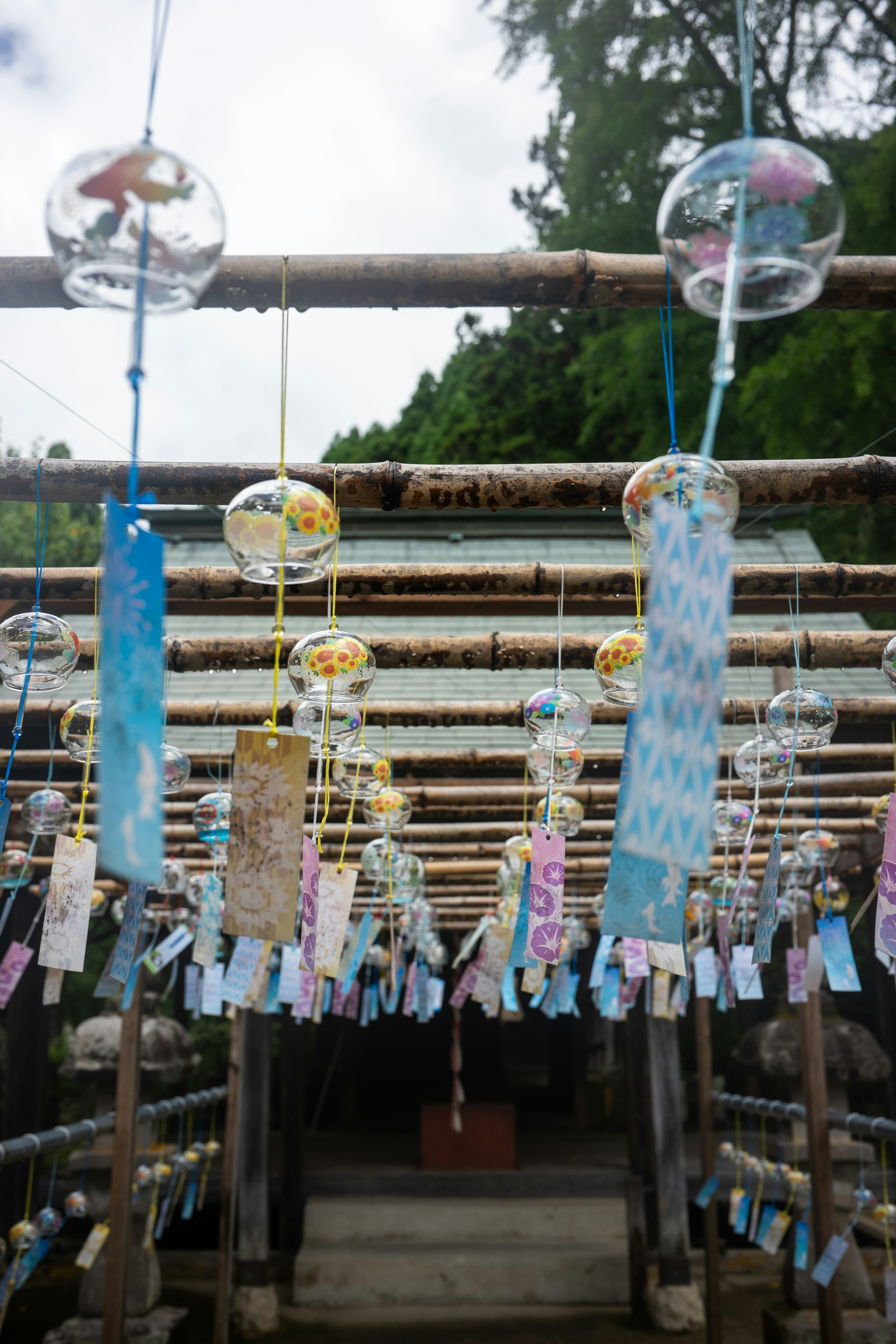 Glass wind chimes hang at an entryway.