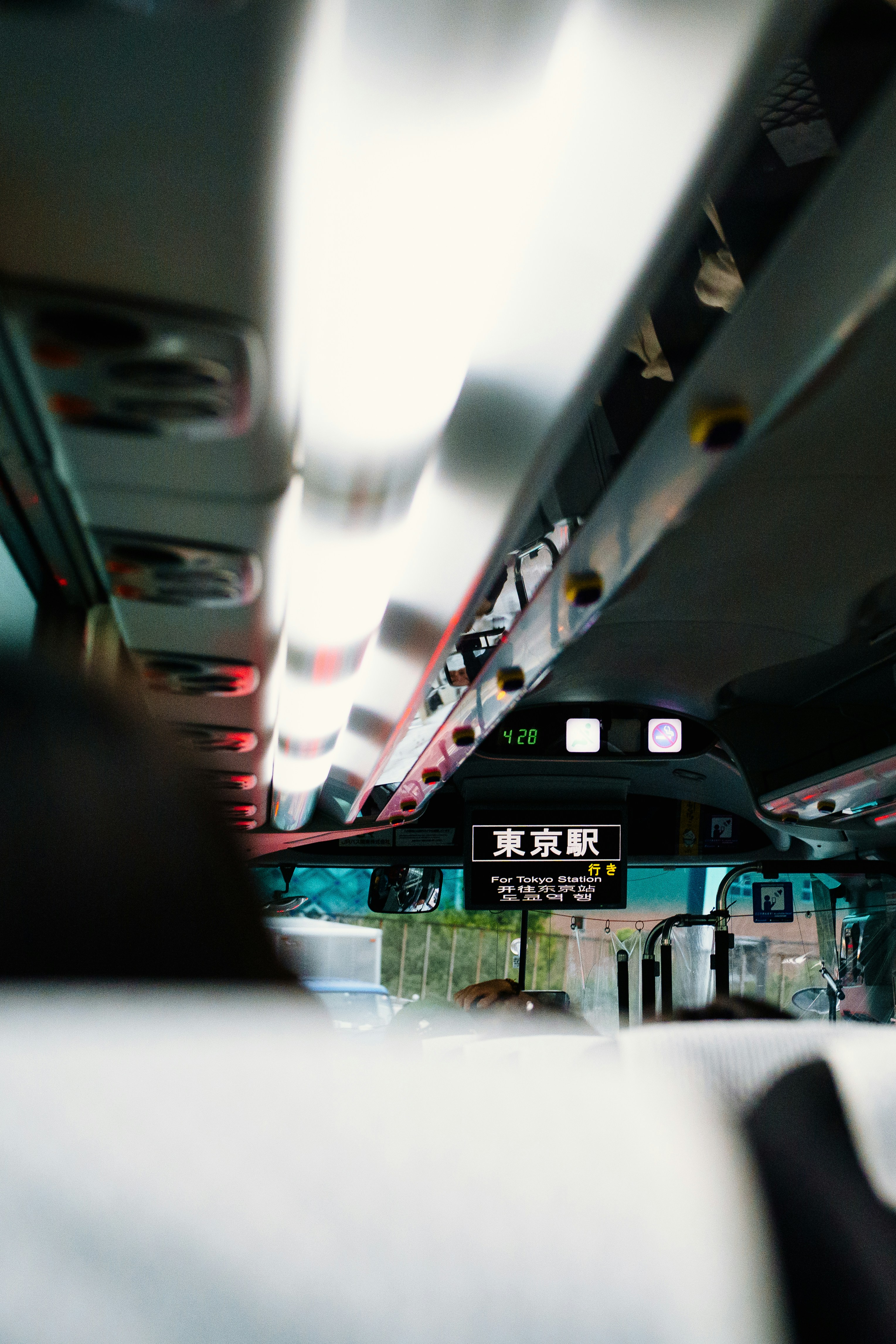 Inside a bus: tokyo station sign is visible.